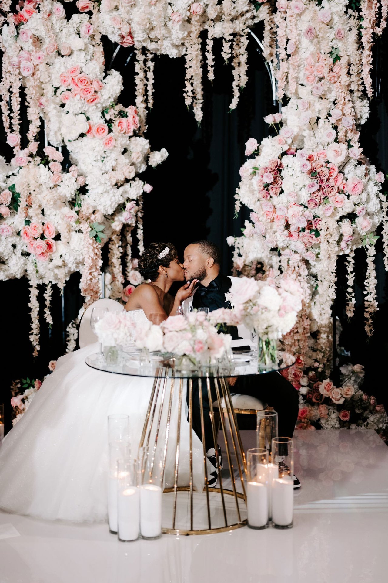 Bride & Groom Kiss at Glam Sweetheart Table