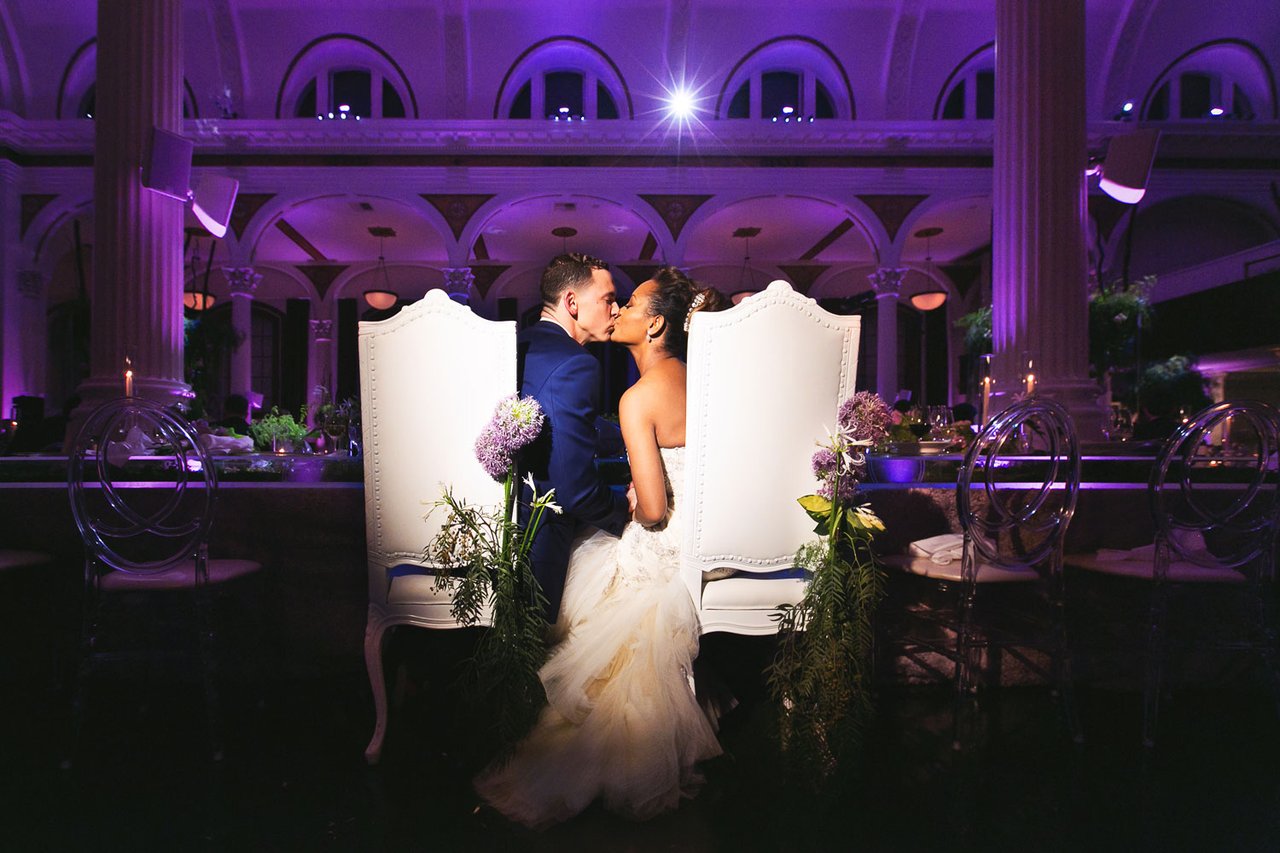 Couple Kiss at Reception Table