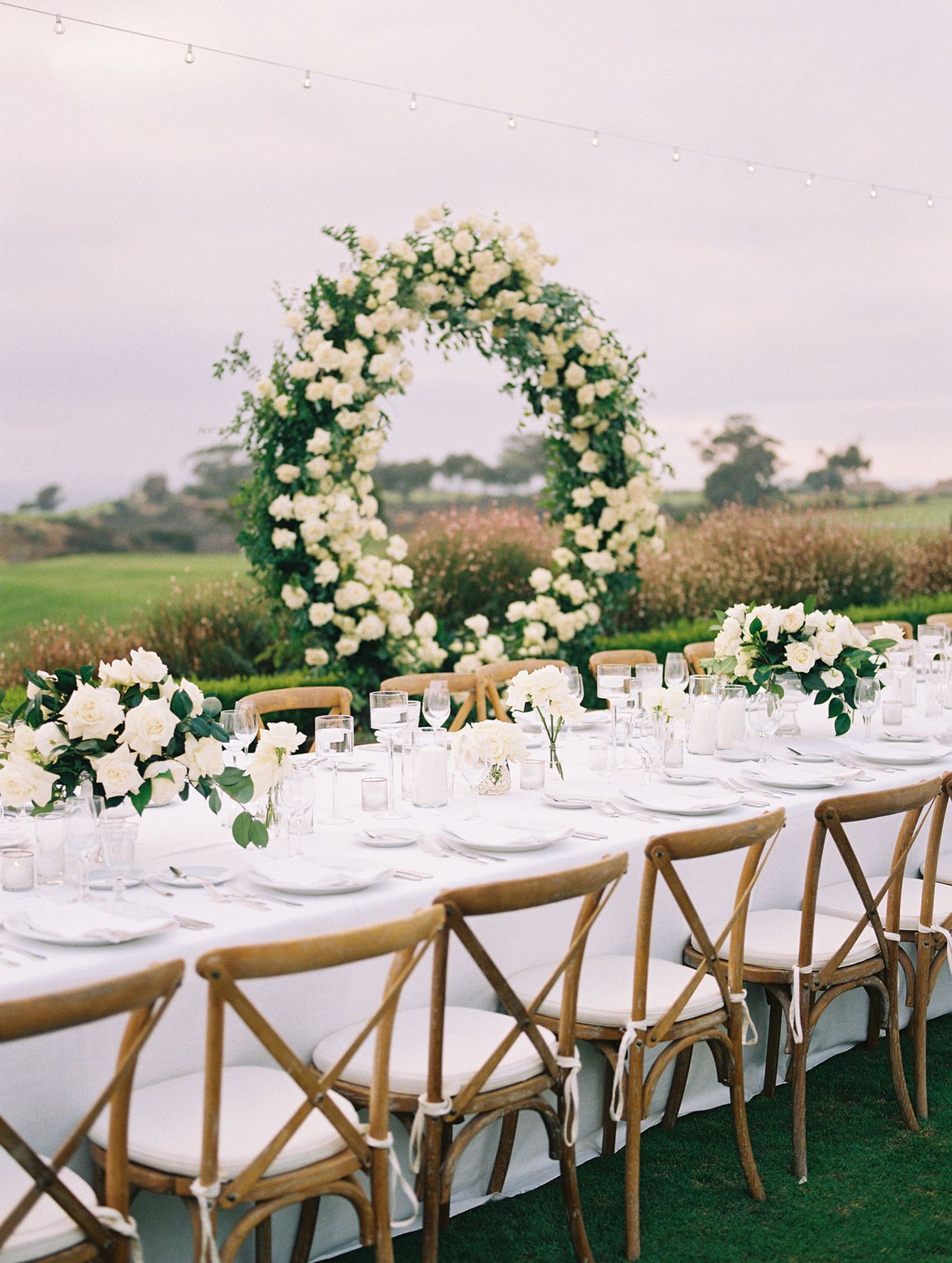 Long Table In Front of Circle Floral Arch