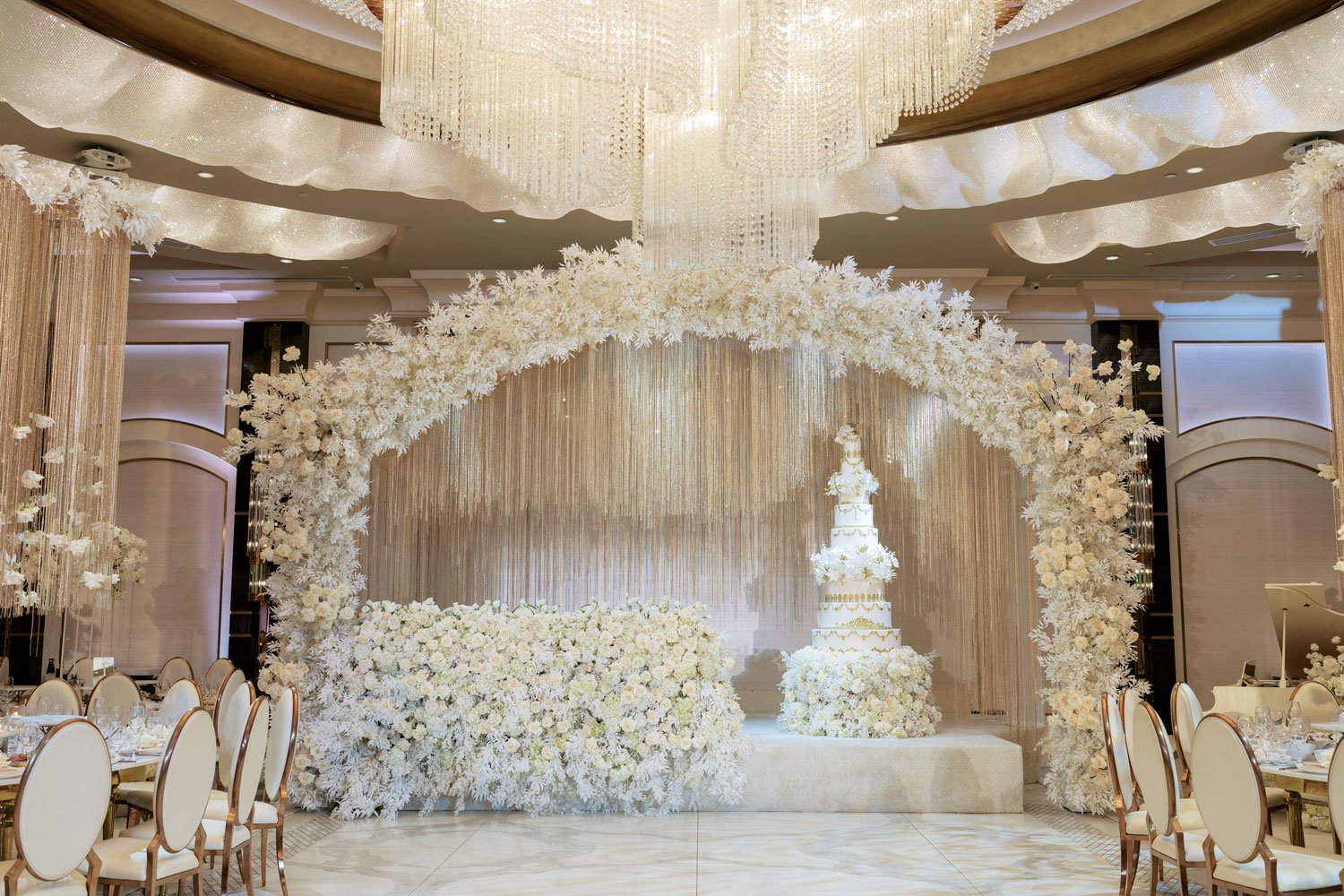 Wedding Cake on Stage with Flower Arch