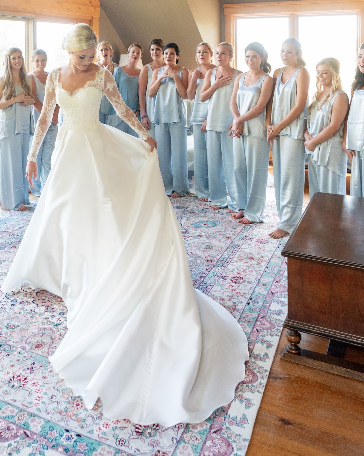 Bride Showing Off Gown to Bridesmaids