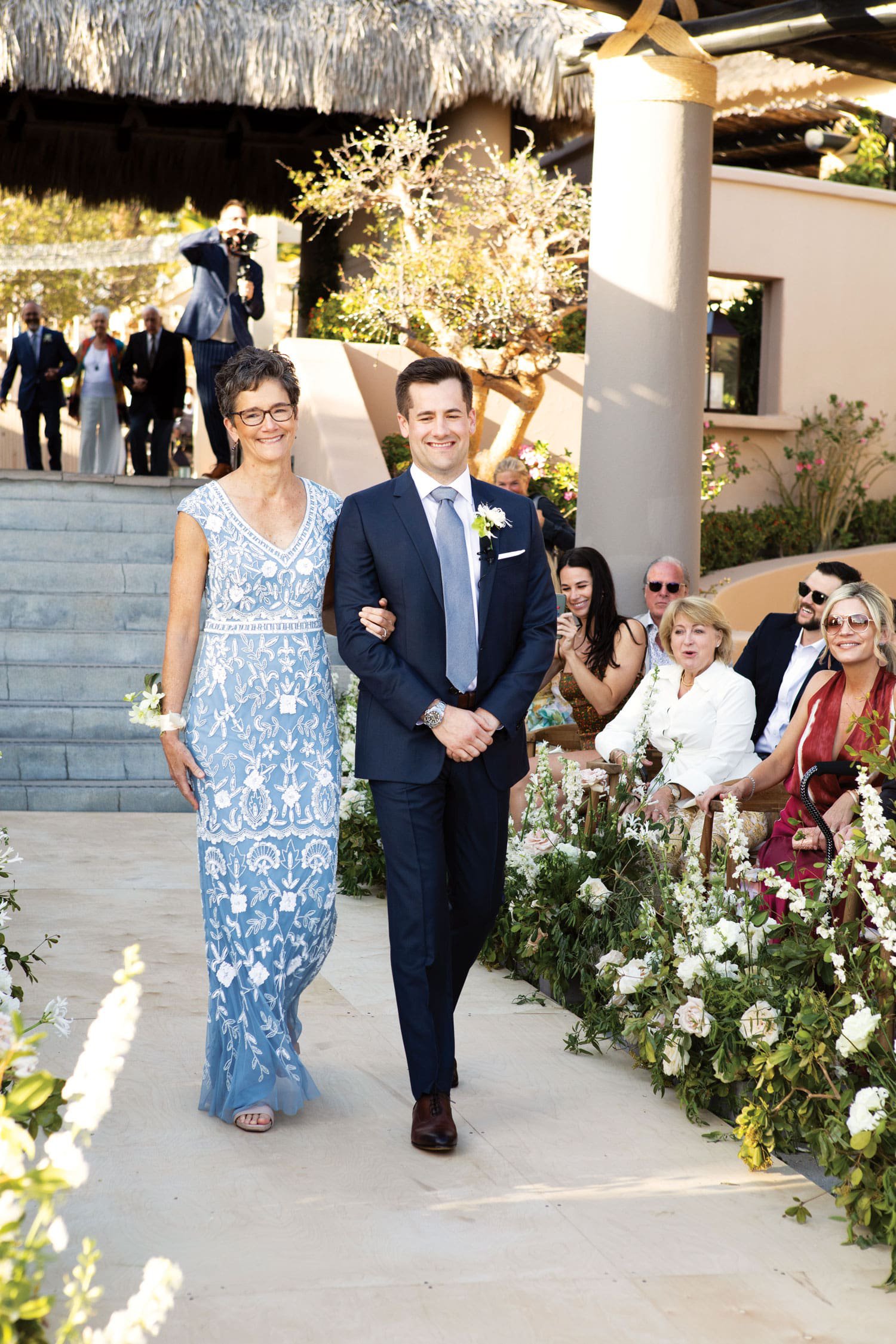Groom Walking Down Aisle with Mom in Blue Dress
