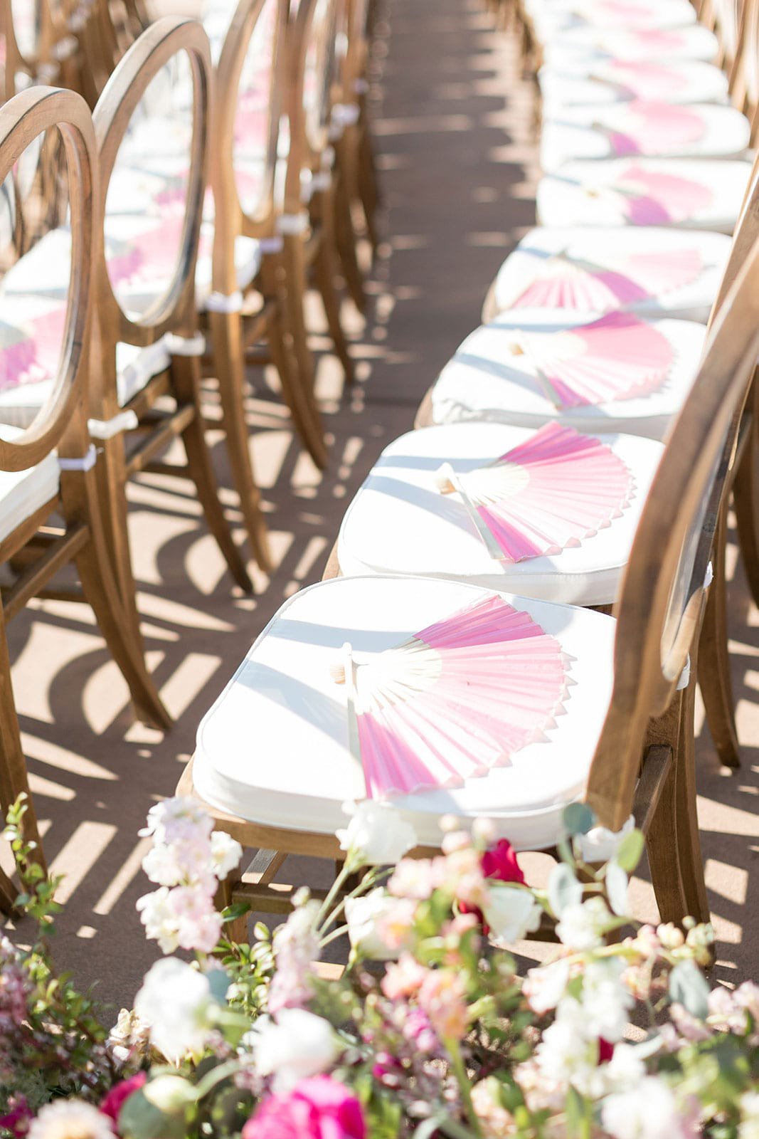 Pink Fans on Wedding Ceremony Chairs