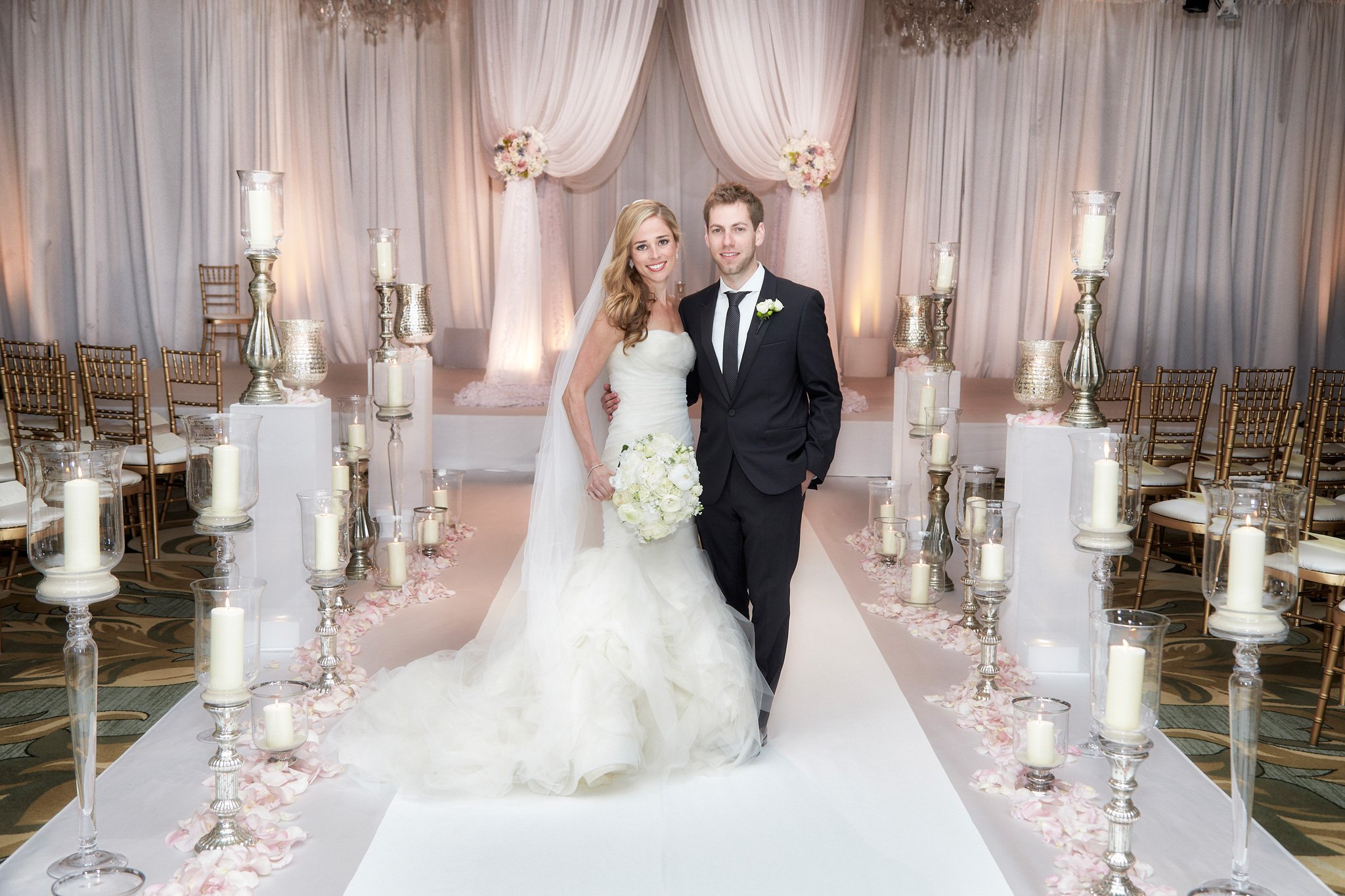 Bride and Groom Pose in Aisle