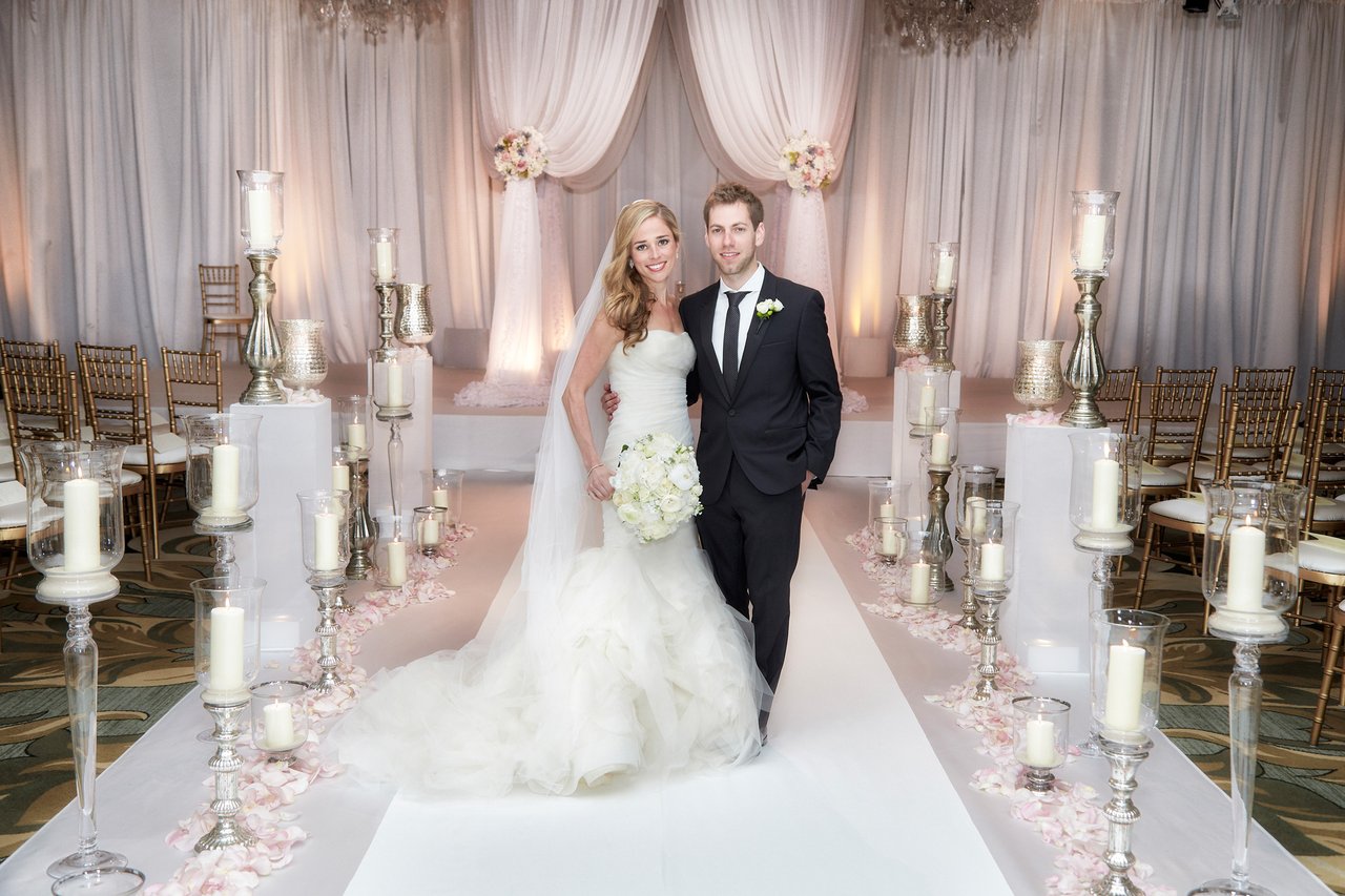 Bride and Groom Pose in Aisle