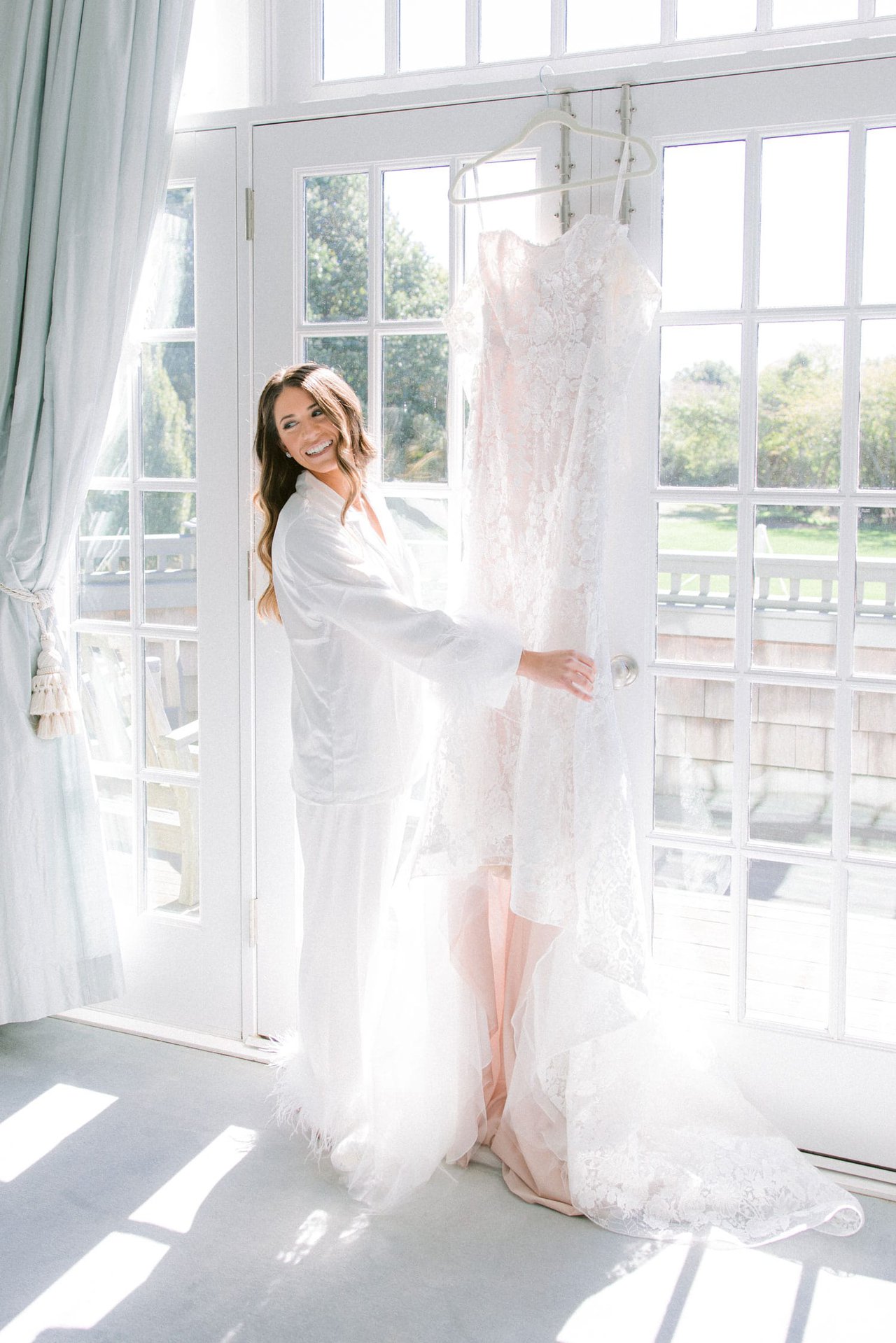 Bride Looking at Wedding Dress in Bridal Suite