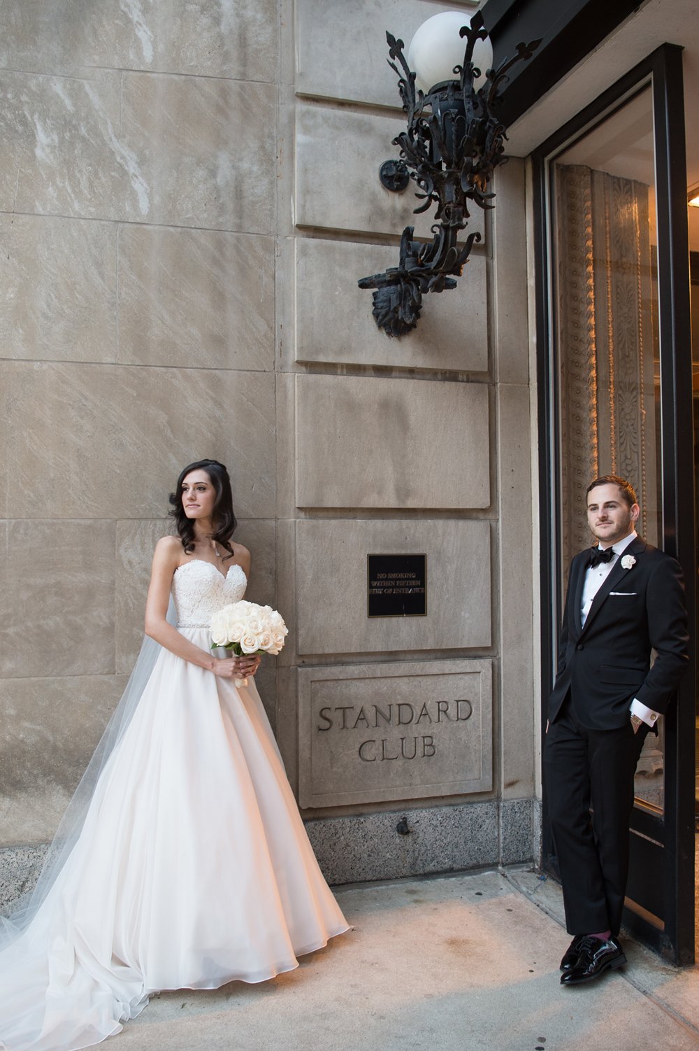 Couple Poses Cooly in Front of Venue