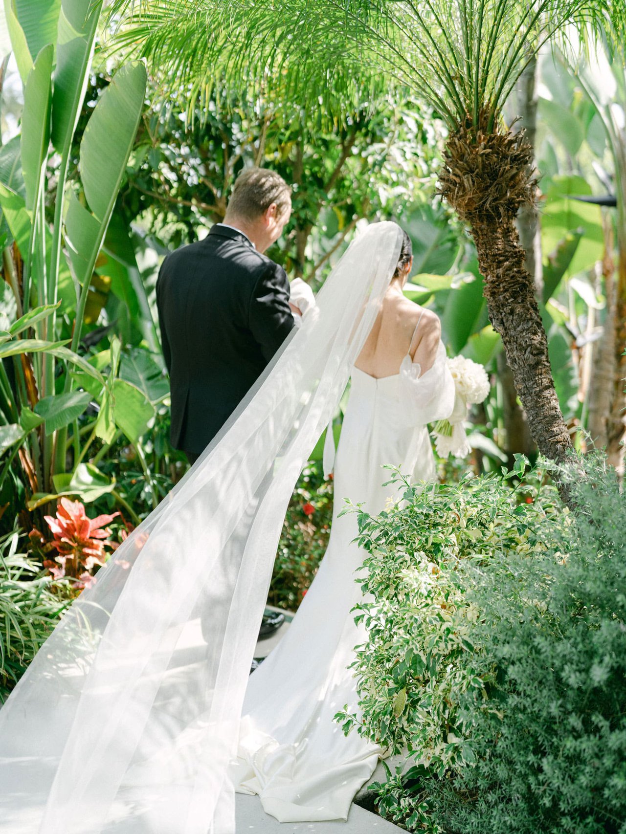 Bridal Veil Trailing Behind Newlyweds