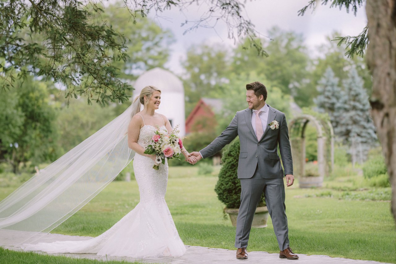 Groom Leading Bride at Farm Wedding Venue