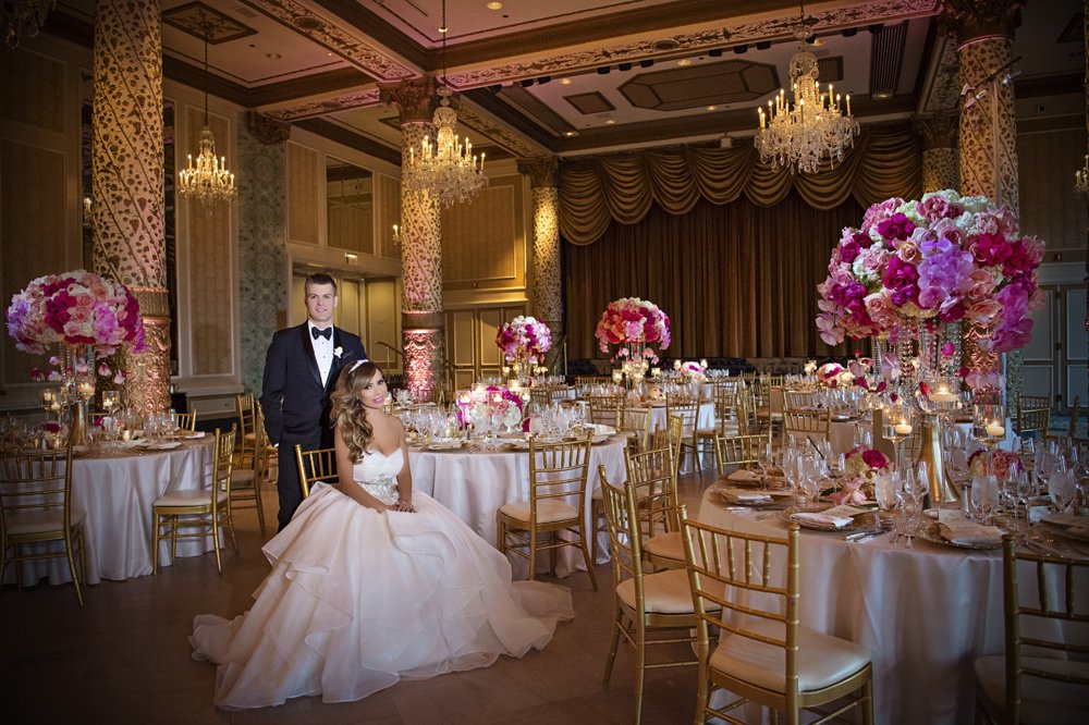 Newlyweds Pose in Reception Space