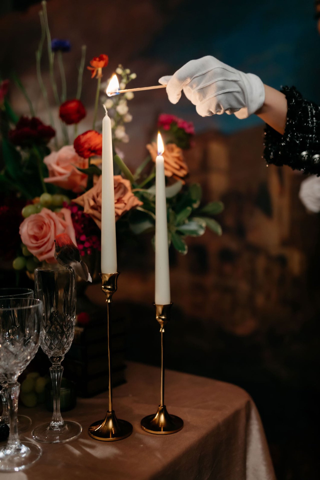 White Gloved Hand Lighting Taper Candle