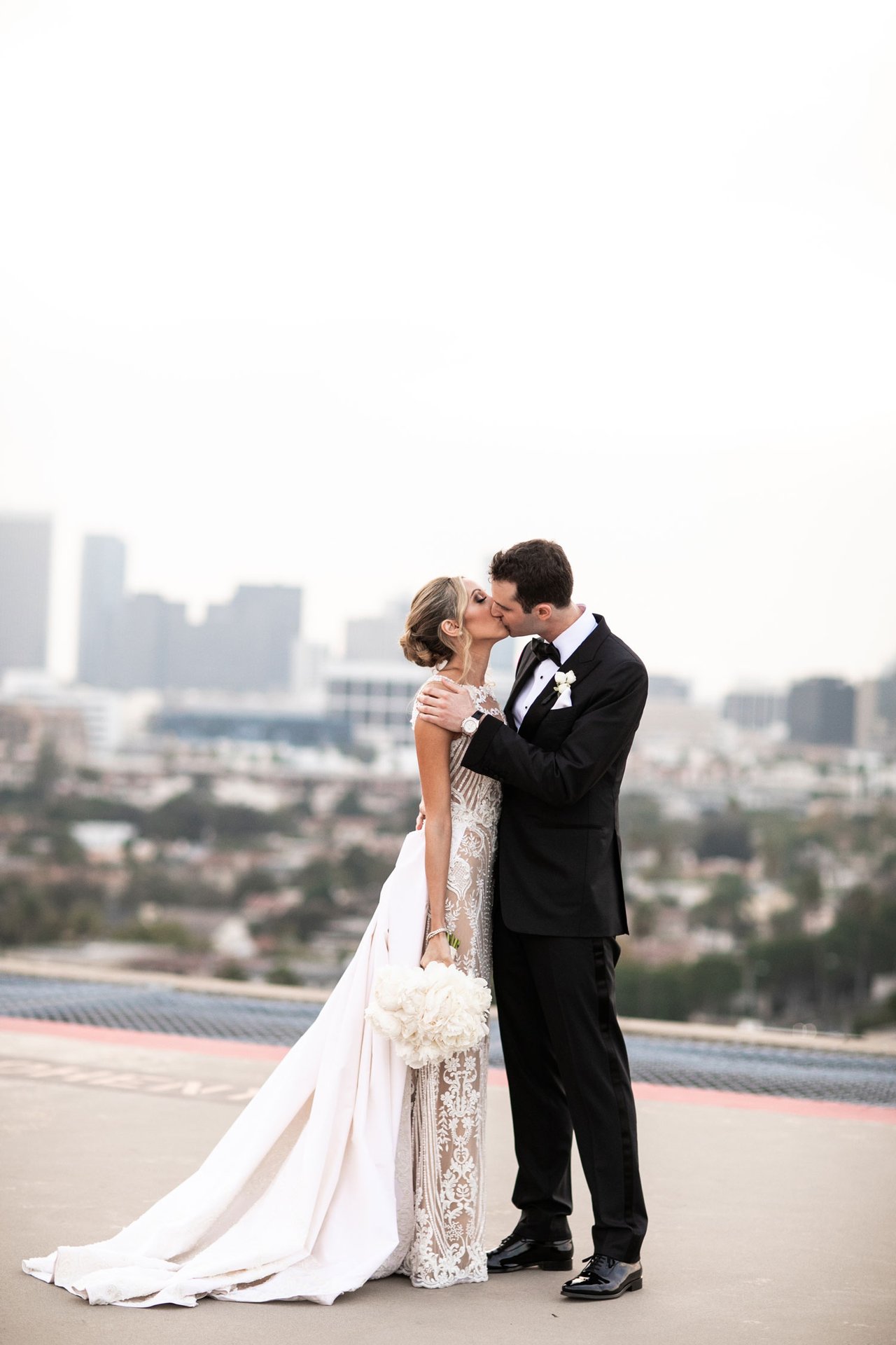 Couple Kisses on Rooftop of Hotel
