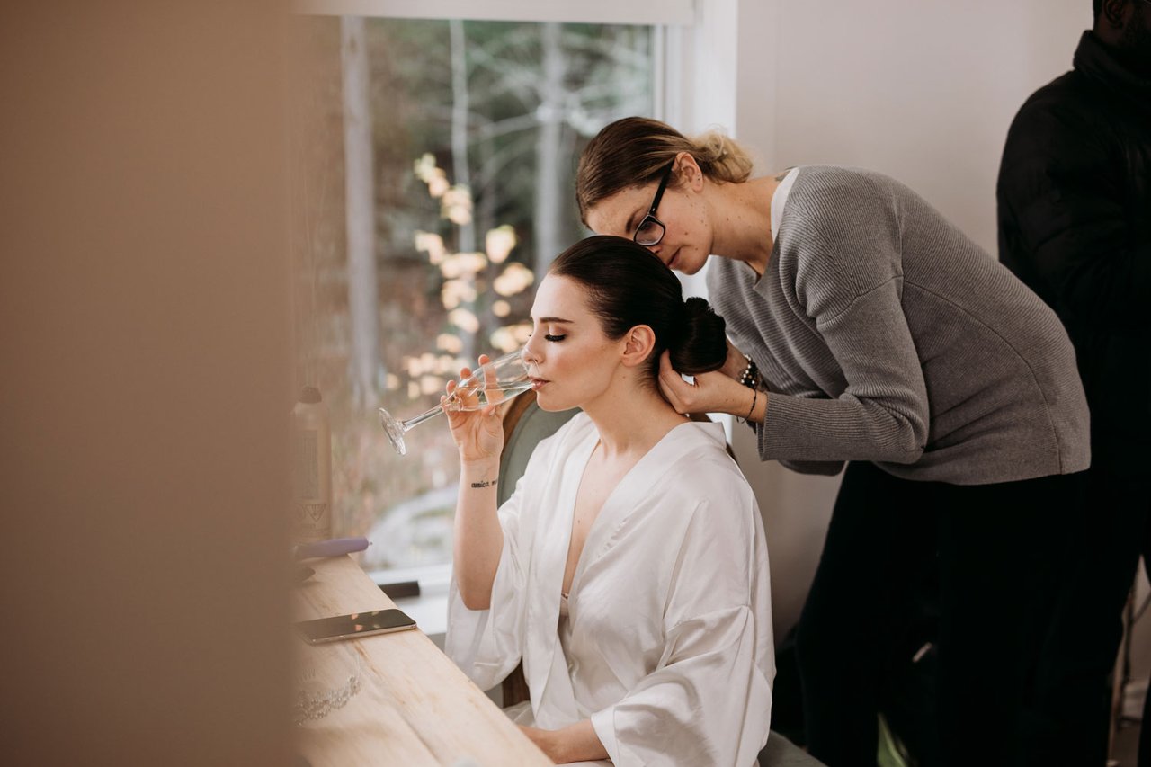 Bride Sipping Champagne While Getting Ready