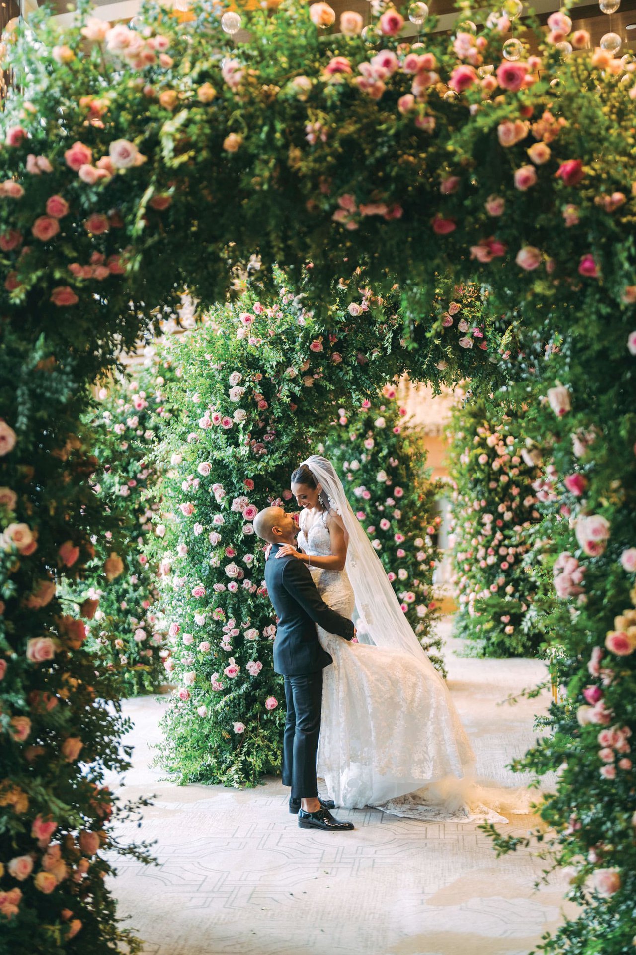 Bride & Groom Under Floral Arch Pathway