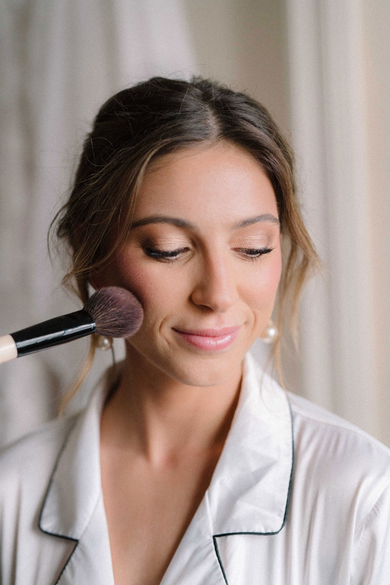 Bride Getting Makeup Done on Wedding Day