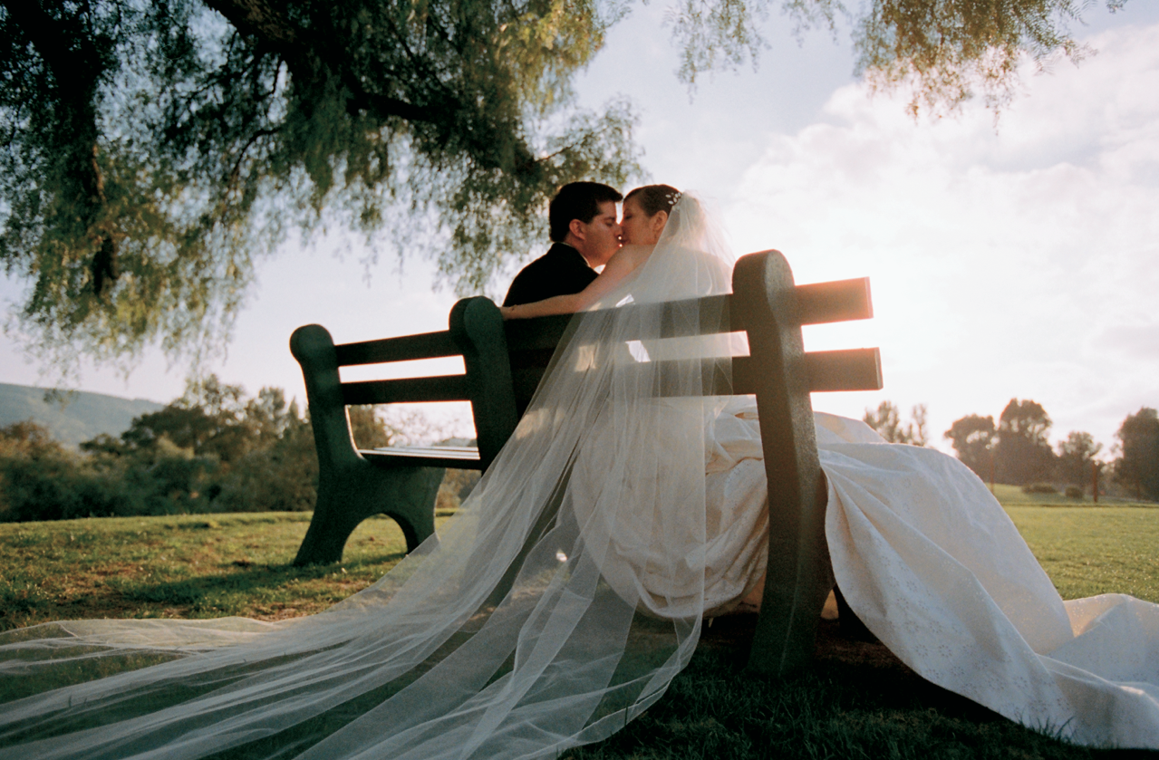 Couple Kissing on Park Bench