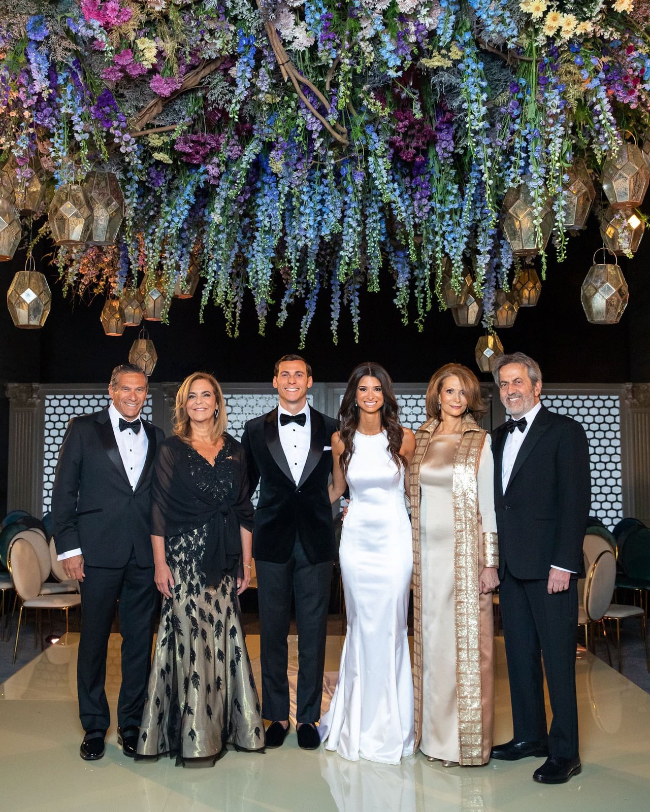 Couple with Parents Under Floral Installation