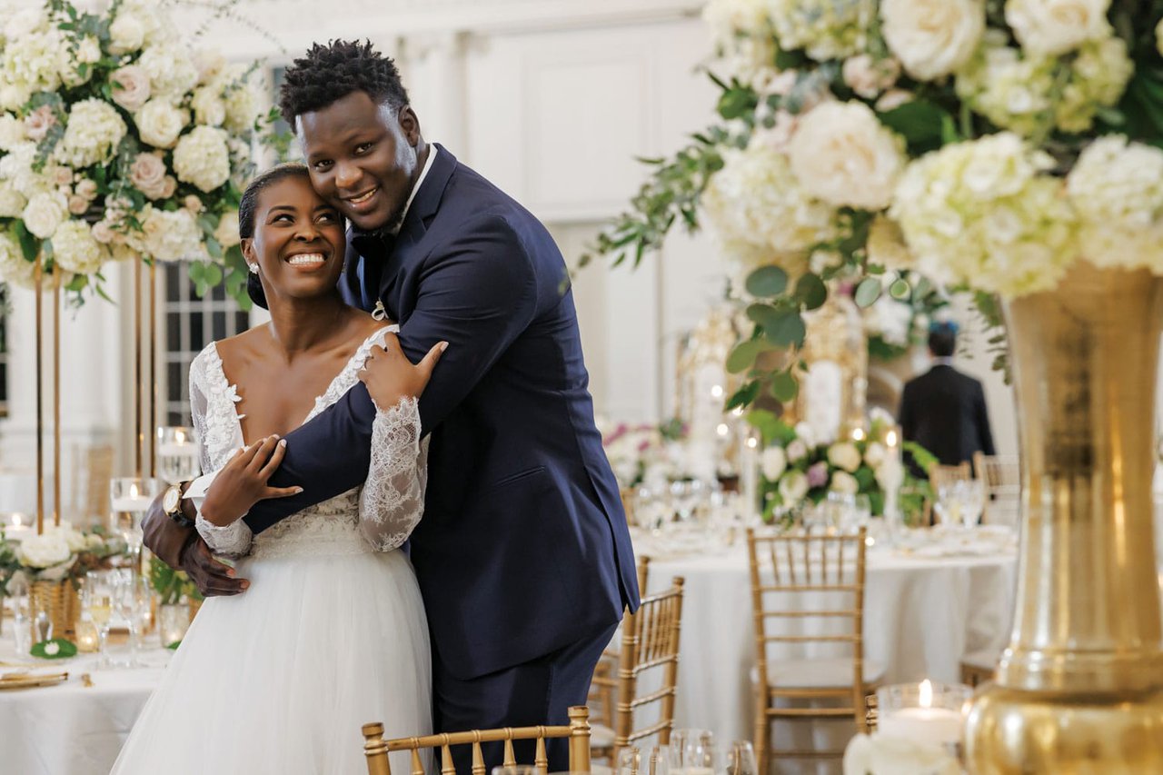 Bride & Groom Embrace in Wedding Ballroom