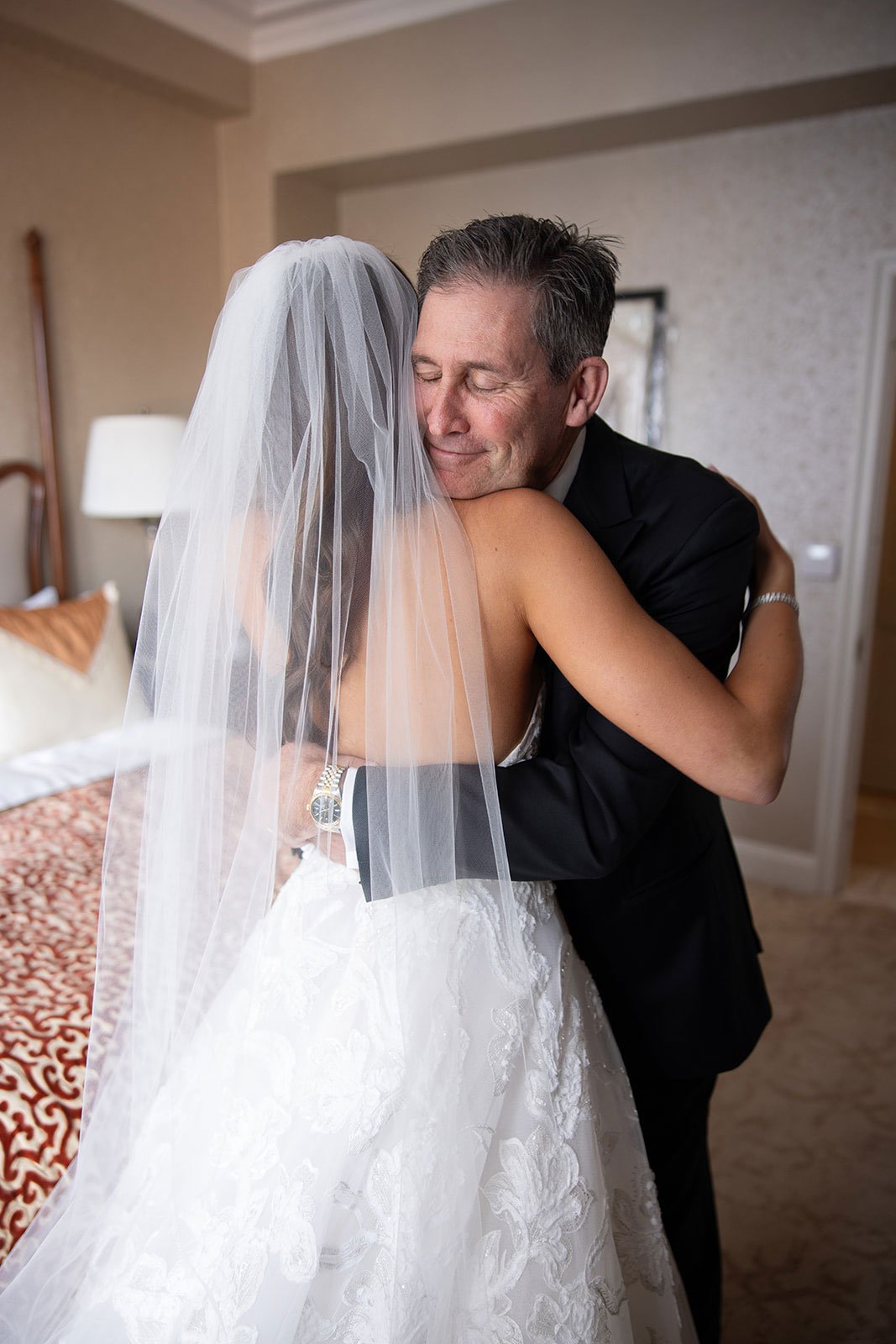 Bride Hugging Father in Bridal Suite