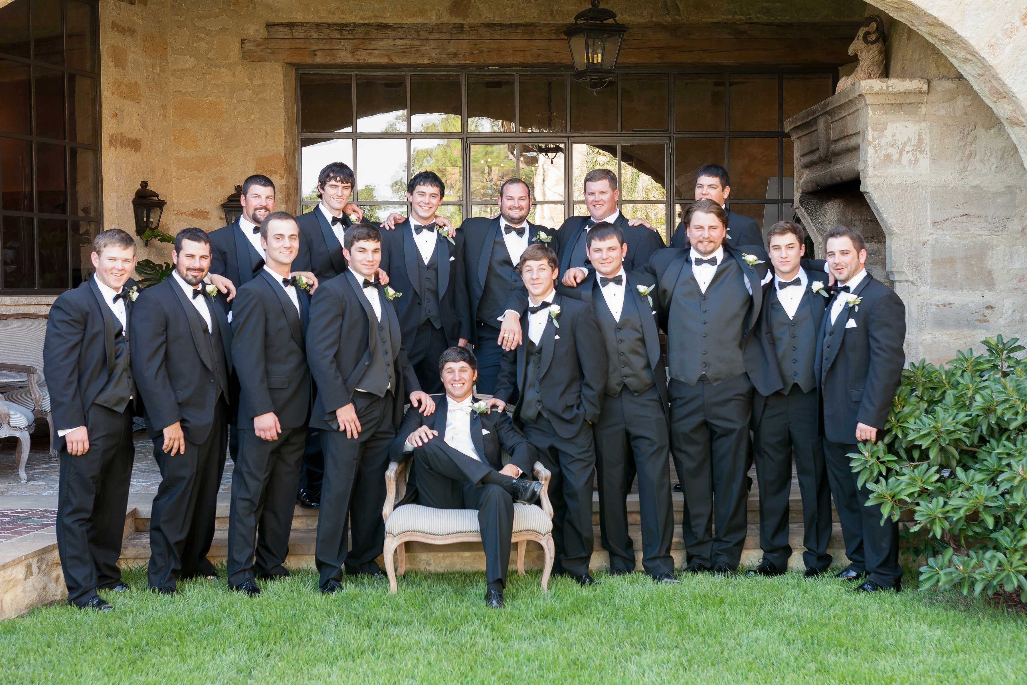 Groom in Chair Surrounded by Groomsmen