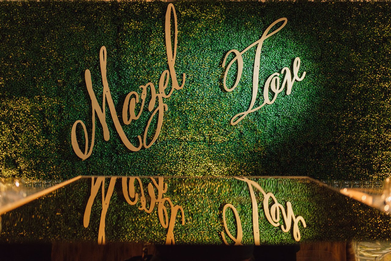 "Mazel Tov" Calligraphy Sign on Hedge