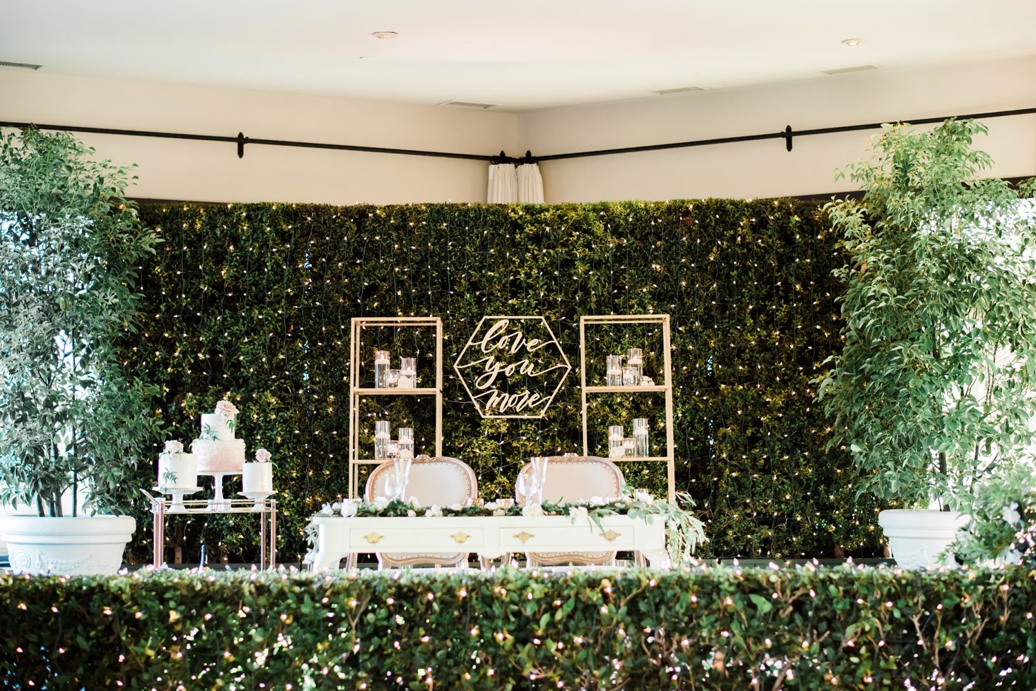 Sweetheart Table in Front of Hedge Wall