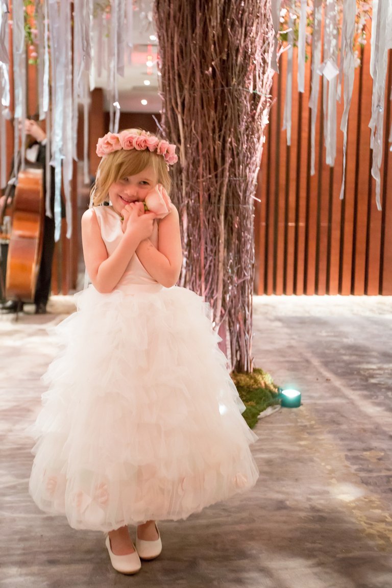 Flower Girl Grasping a Pink Rose