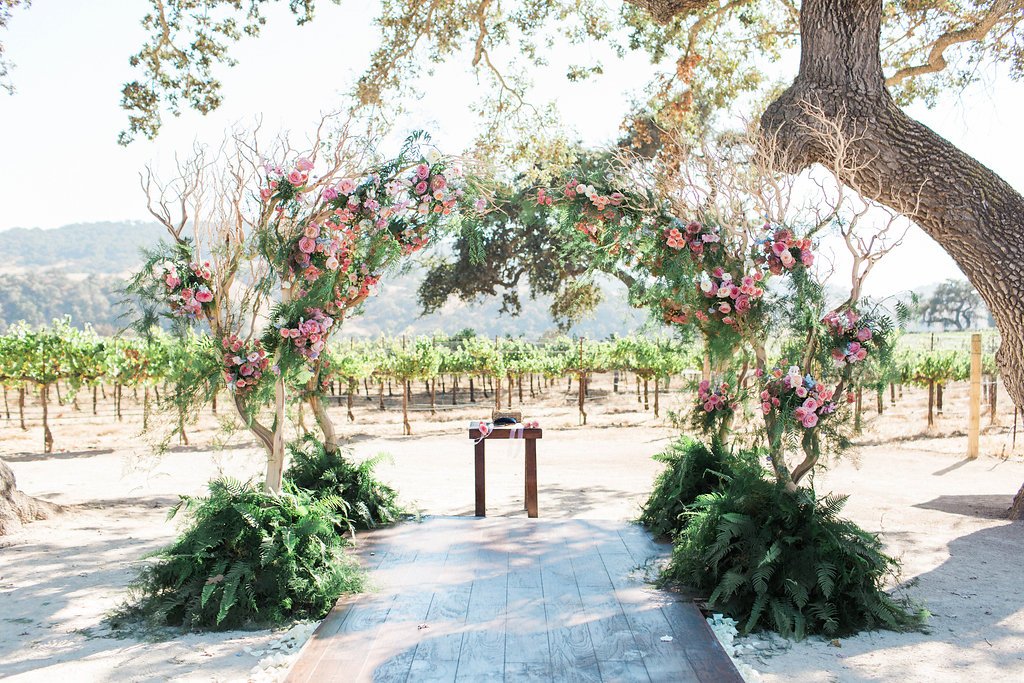 Chuppah out of Four Trees and Blush Florals