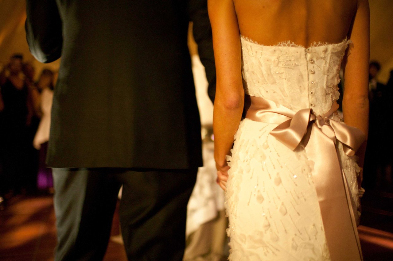 Back of Bride and Groom's Wedding Dress and Tuxedo