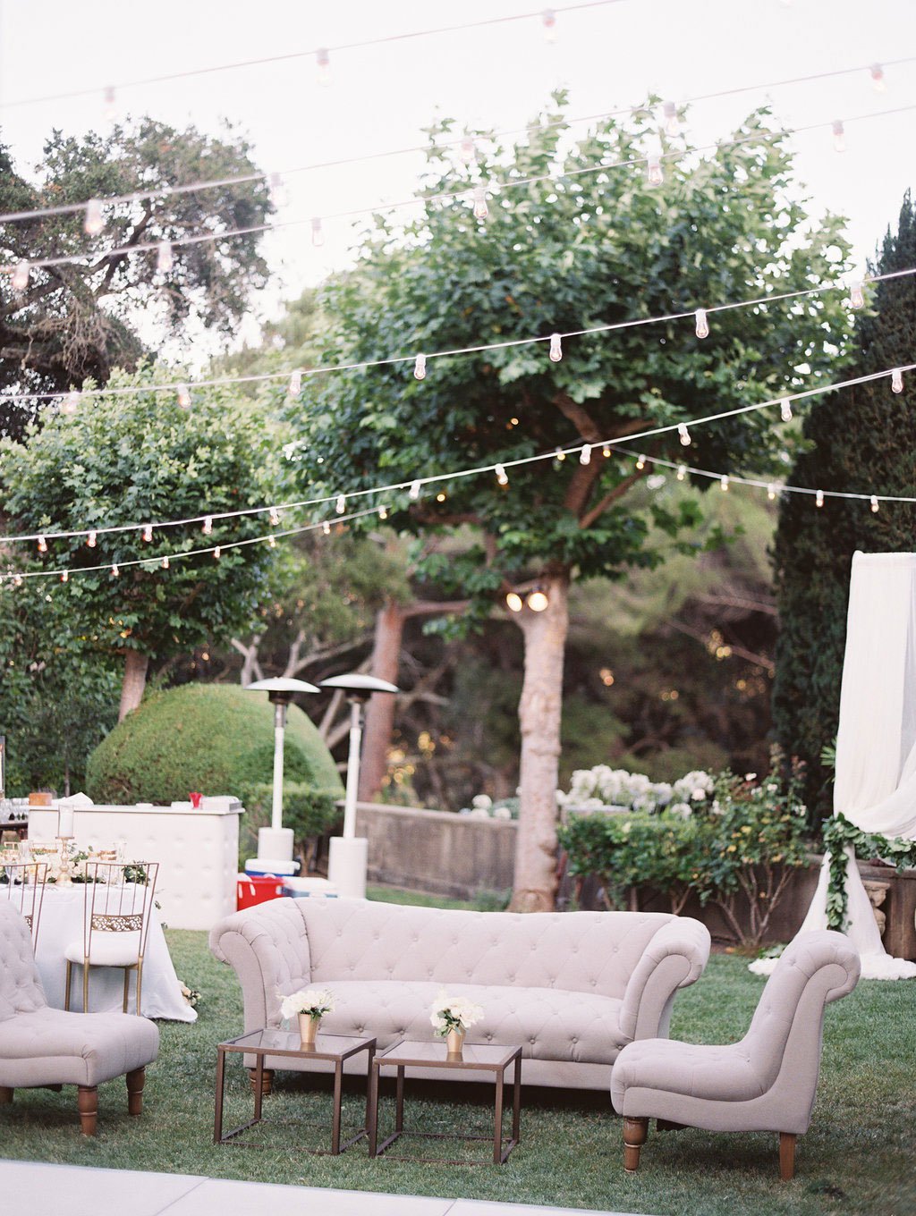 Outdoor Lounge Space Under Strings of Lights