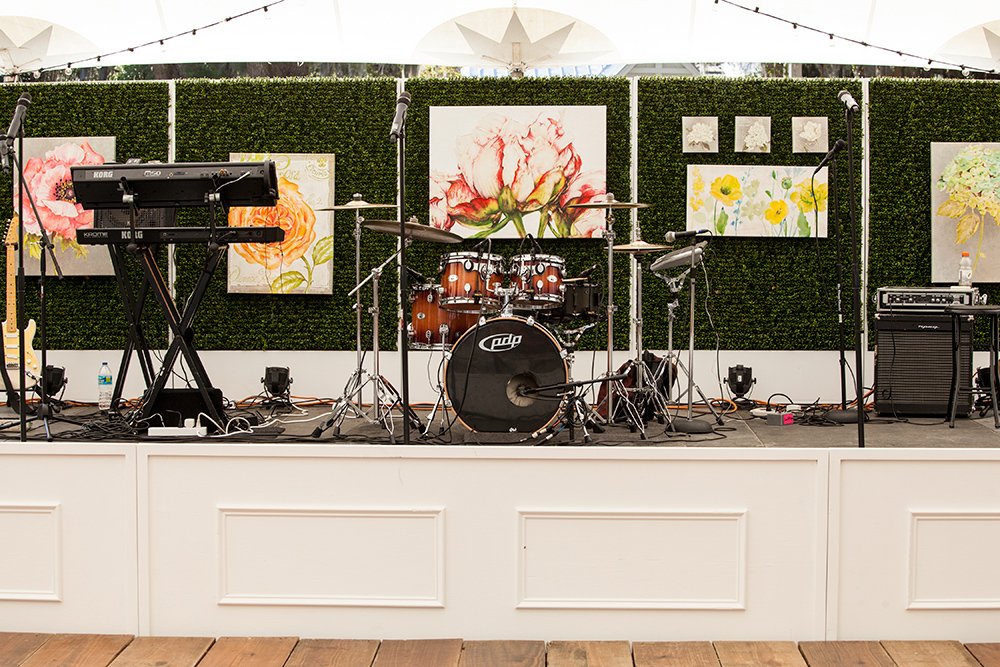 Band Stage in Front of Hedge Wall