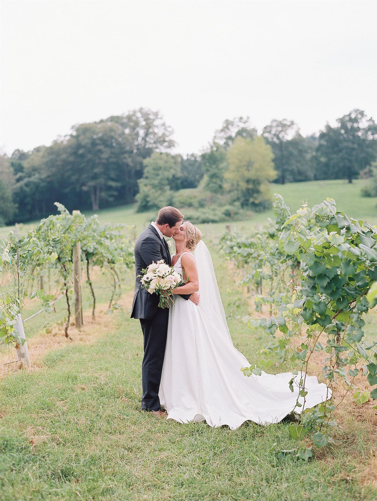 Bride & Groom Kissing in Vineyard