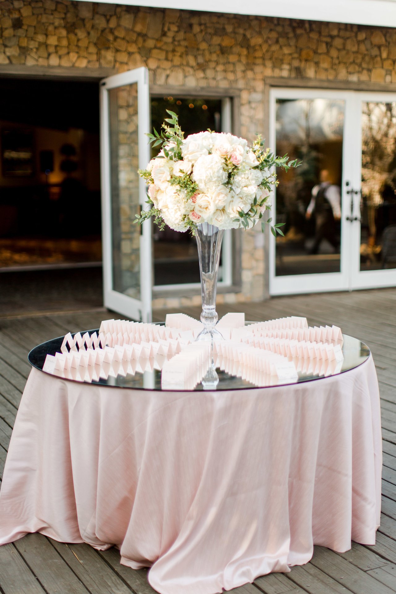 Escort Cards Fanned Out on Mirrored Table