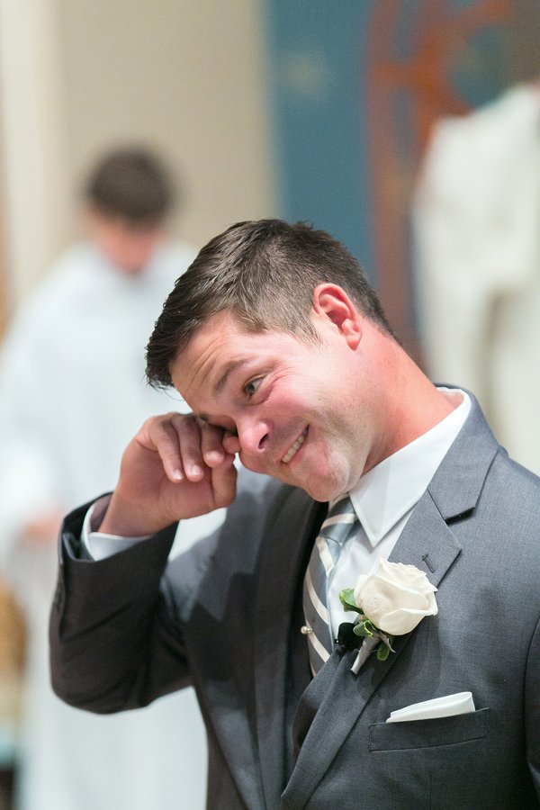 Smiling Groom Brushes Away Tear