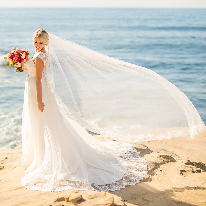 Veil Flowing, Bride on Rocks Over Ocean