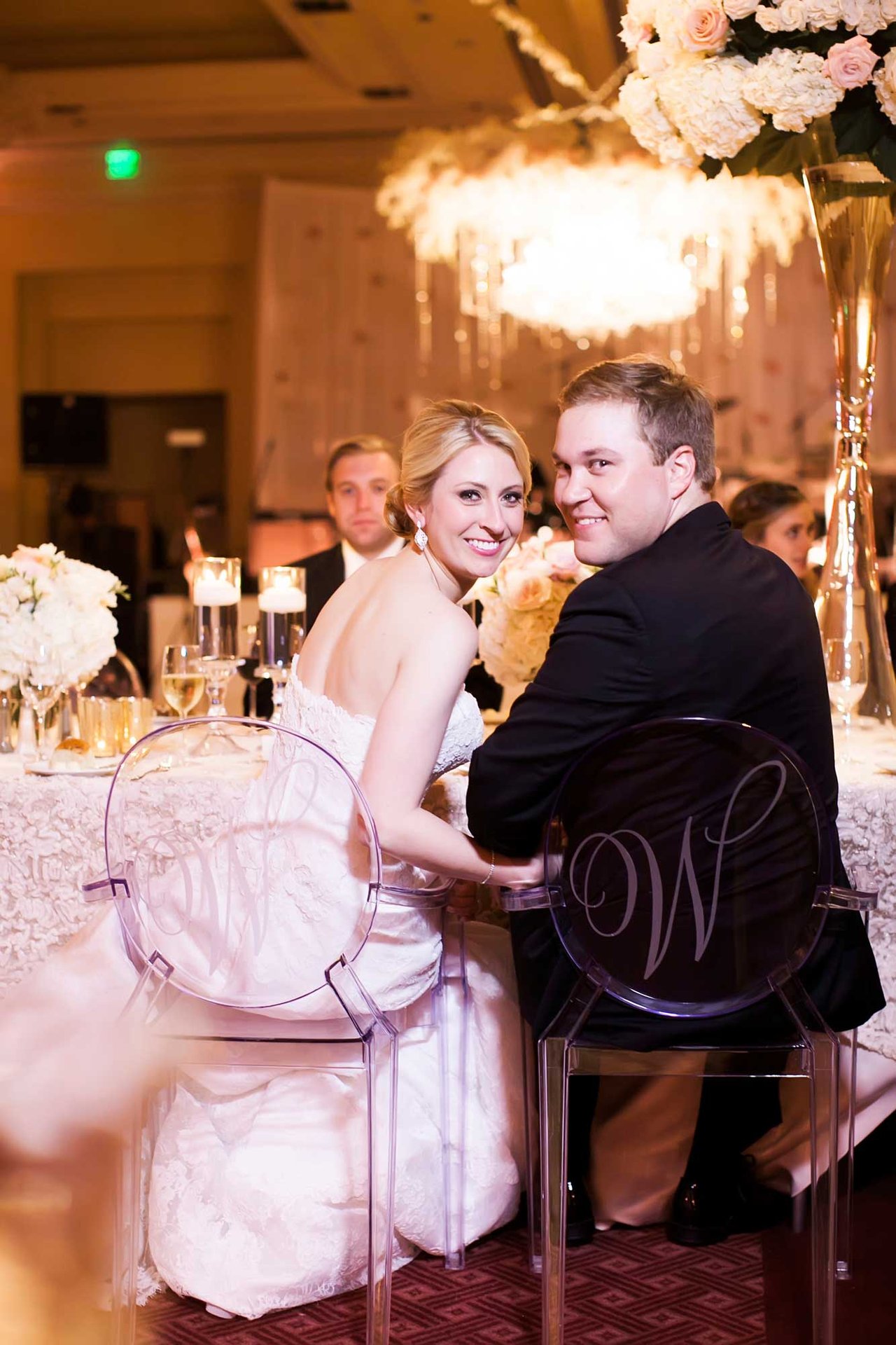 Couple Turns in Reception Chairs to Pose
