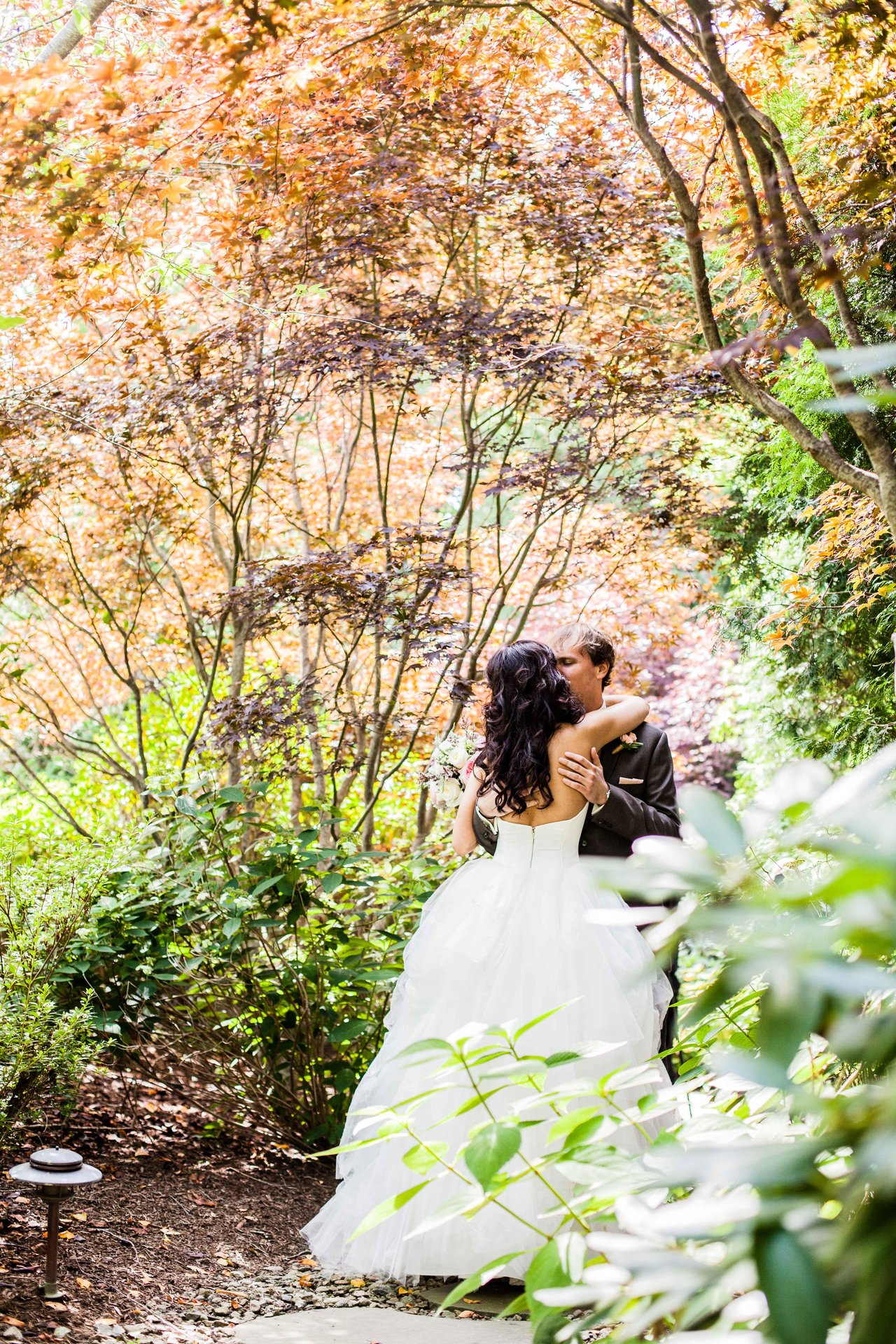 Bride and Groom Embrace in Garden