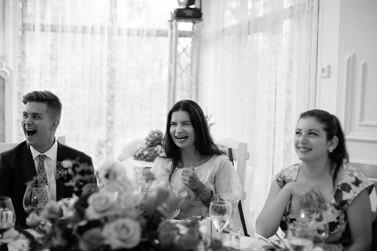 Black-and-White Photo of Guests Laughing