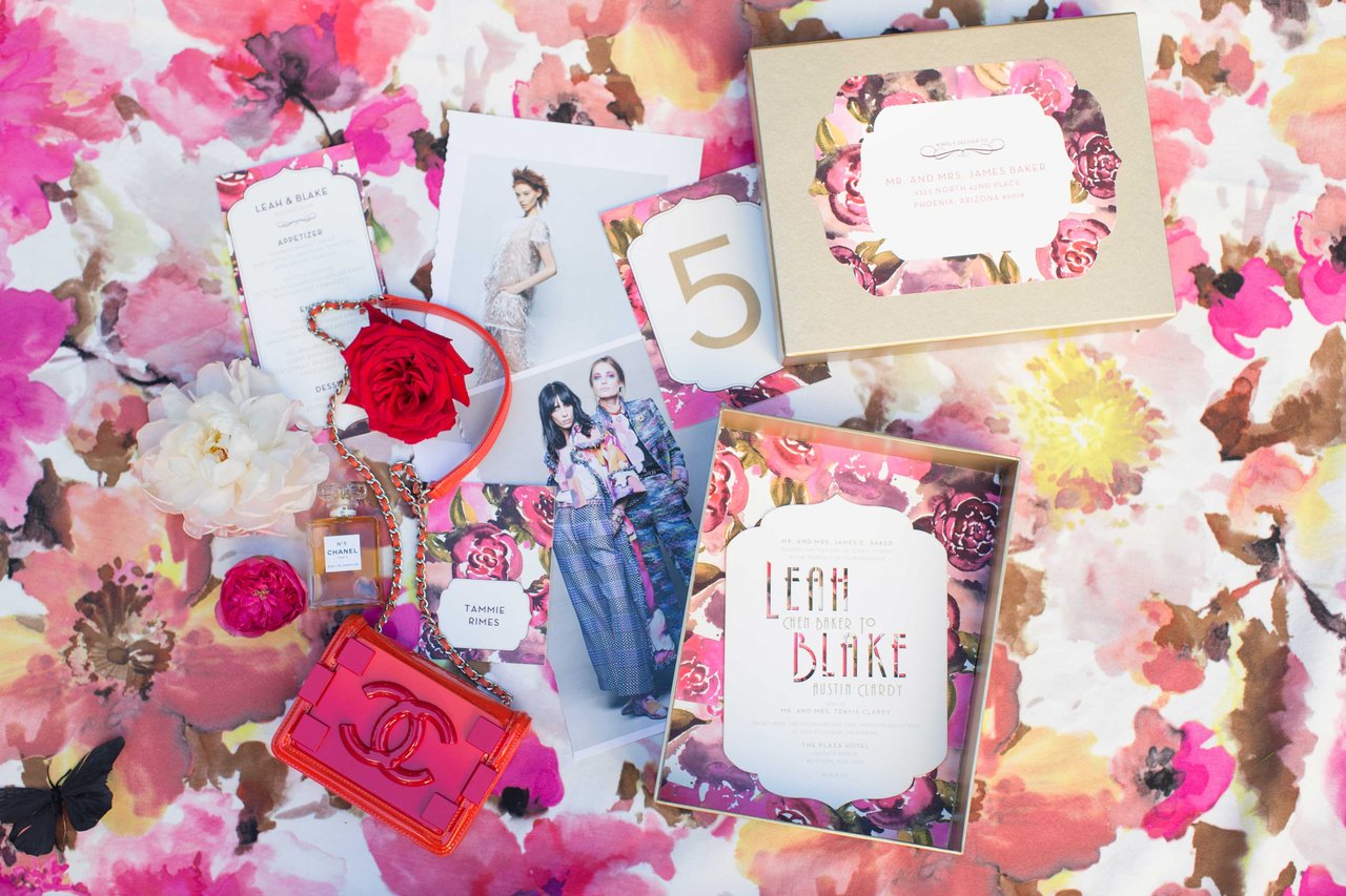 Chanel Paper Products Atop Pink Floral Table Linen
