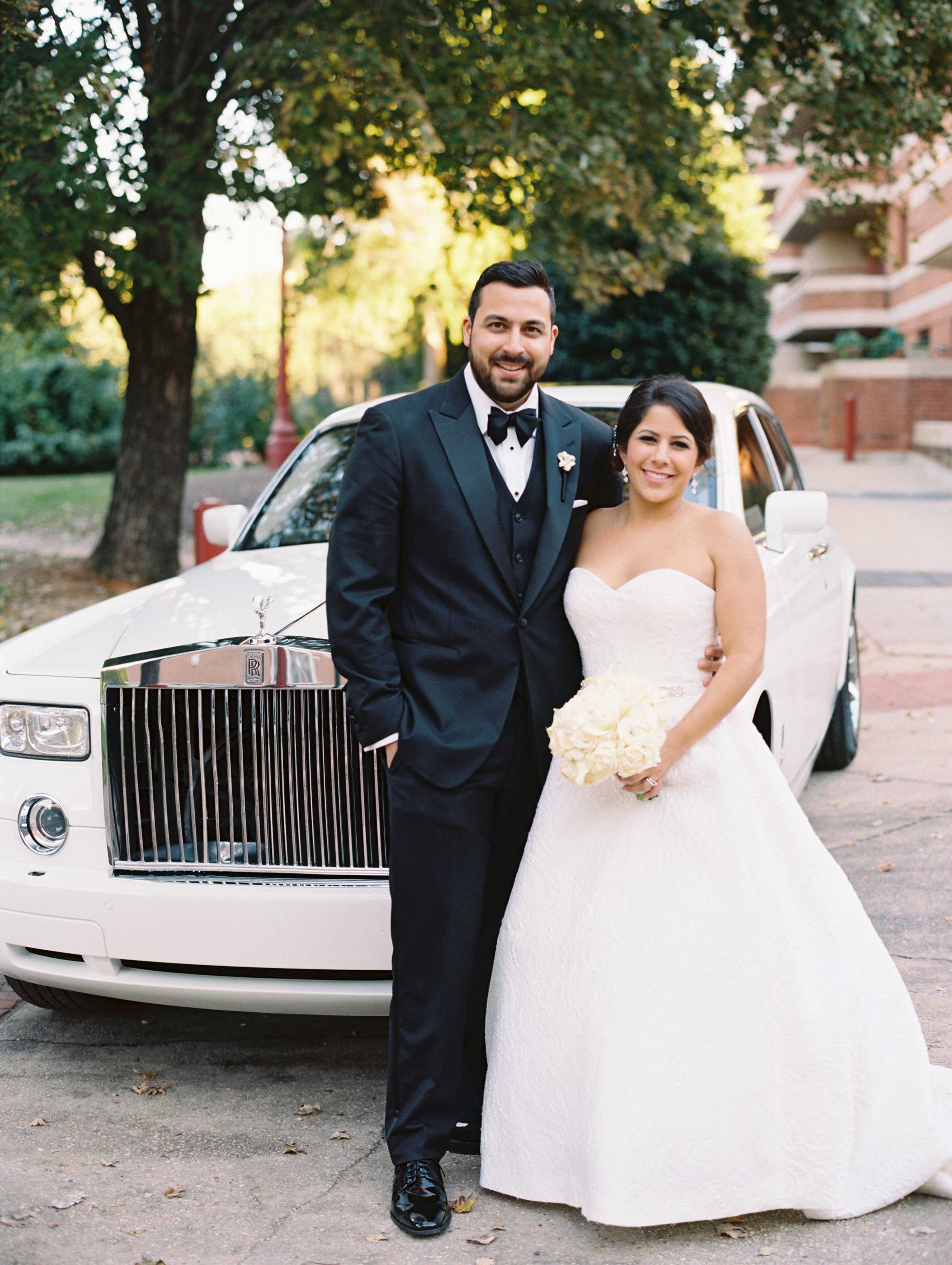 Bride & Groom Smile In Front of Car