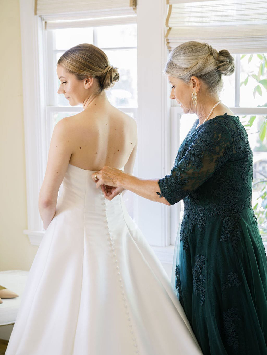 Mother of Bride Helping Daughter with Dress