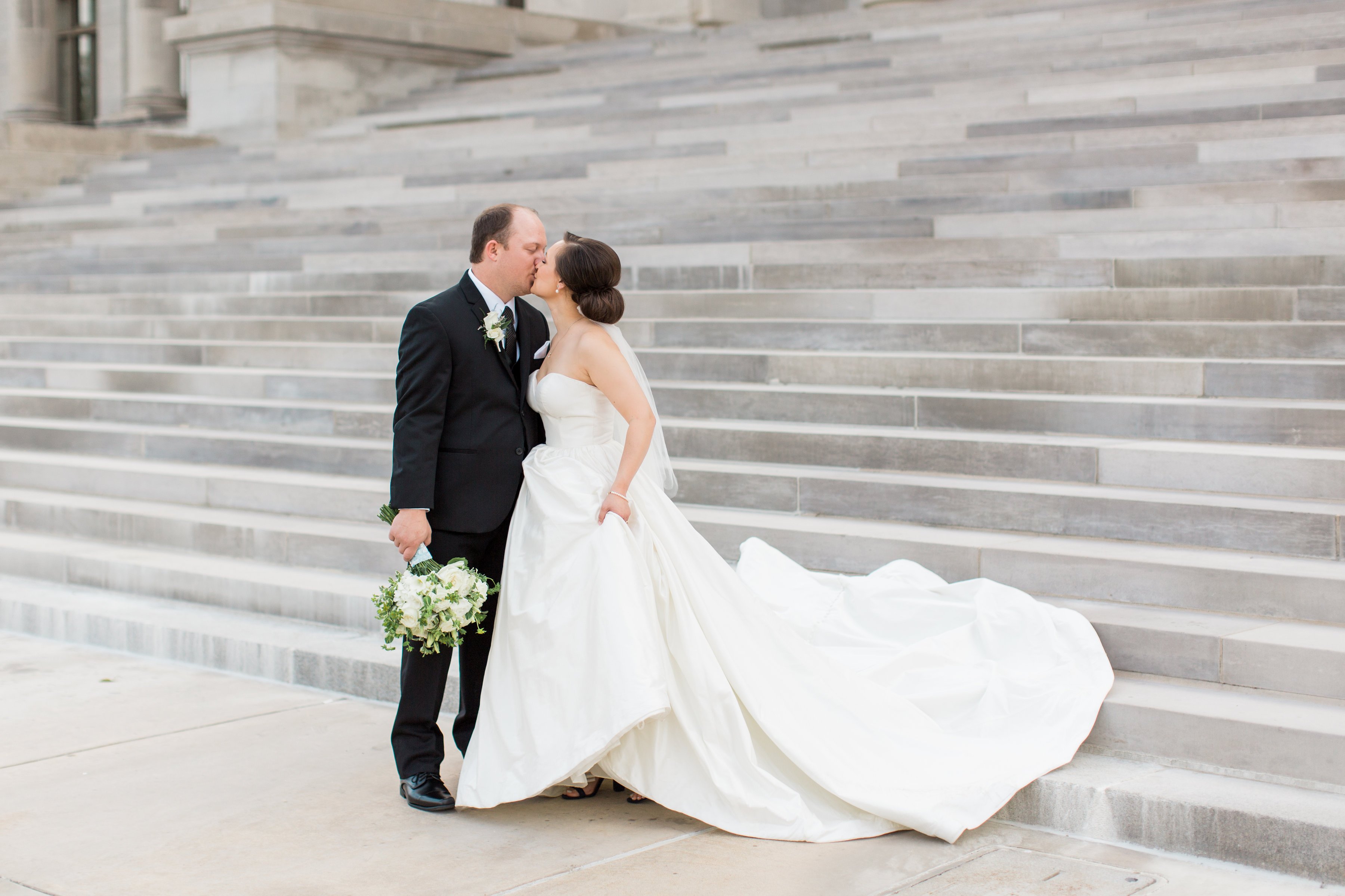 Bride and Groom Kiss at Bottom of Steps