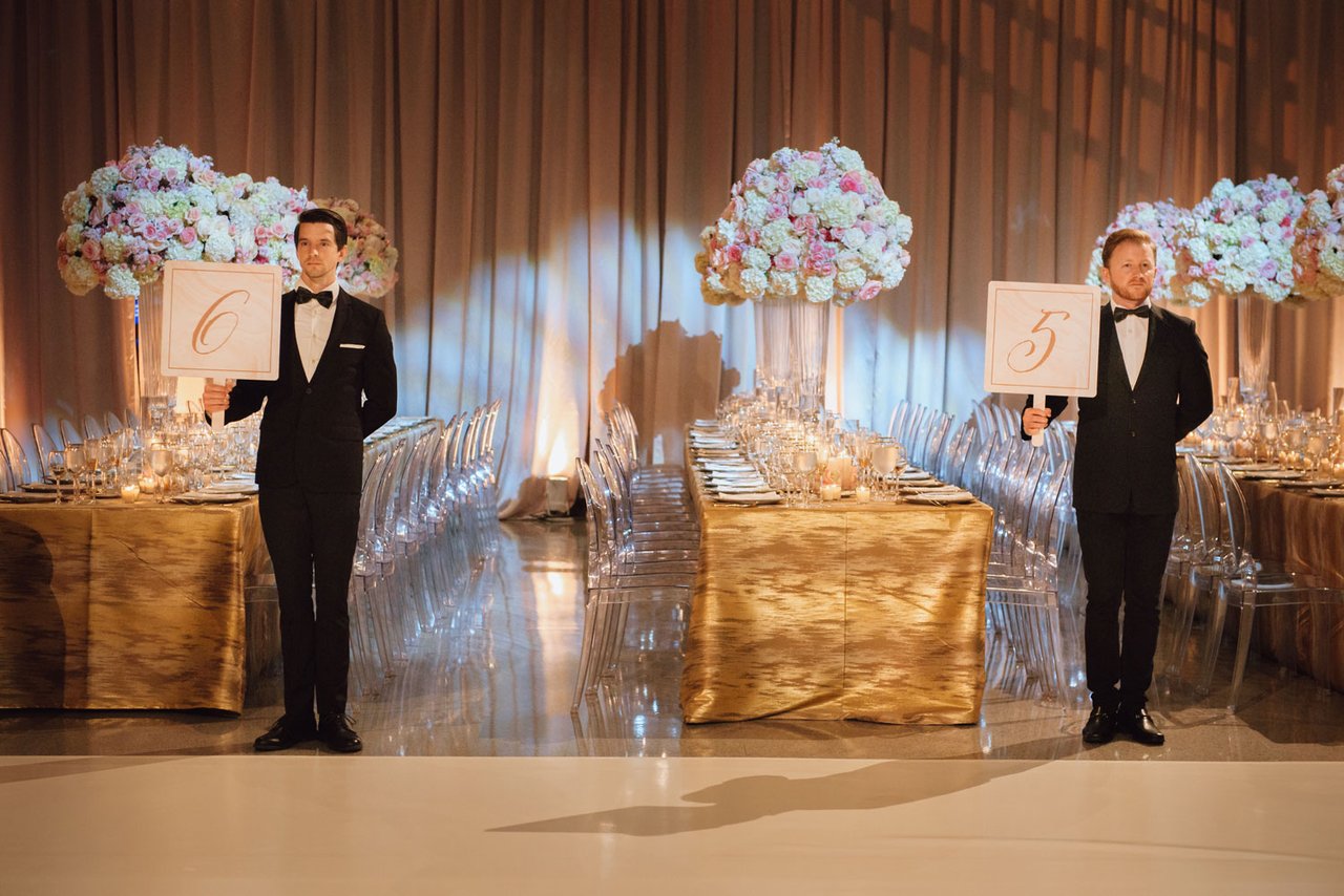 Male Models Holding Table Numbers