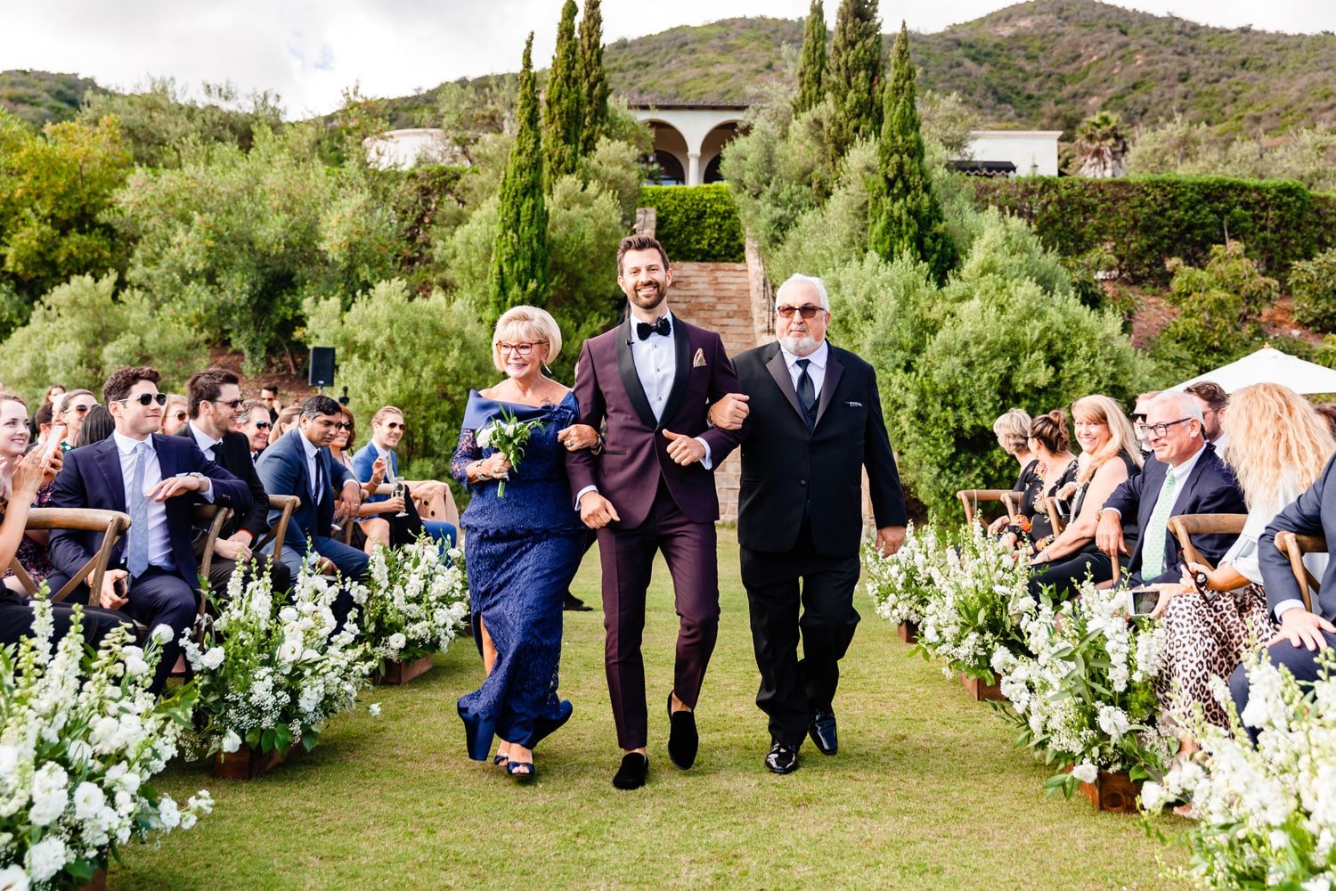 Groom Walking Down Aisle with Parents