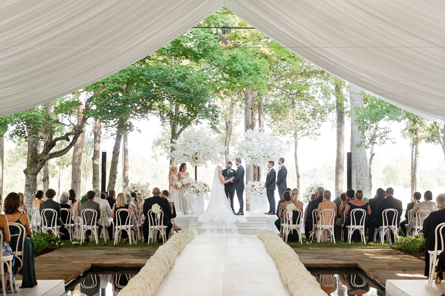Wedding Ceremony Under Tent Over Pool