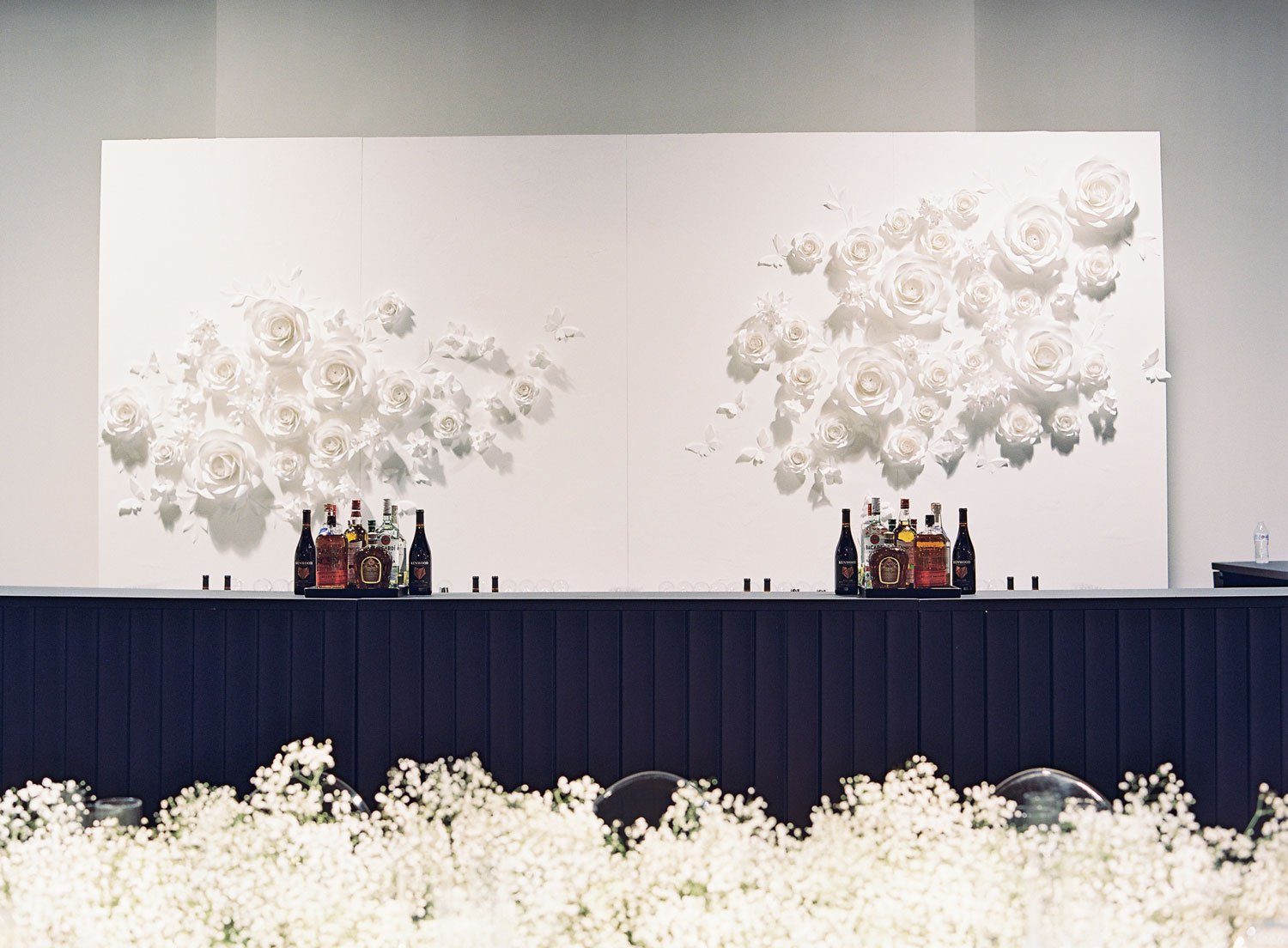 Modern White Roses Behind Wedding Bar