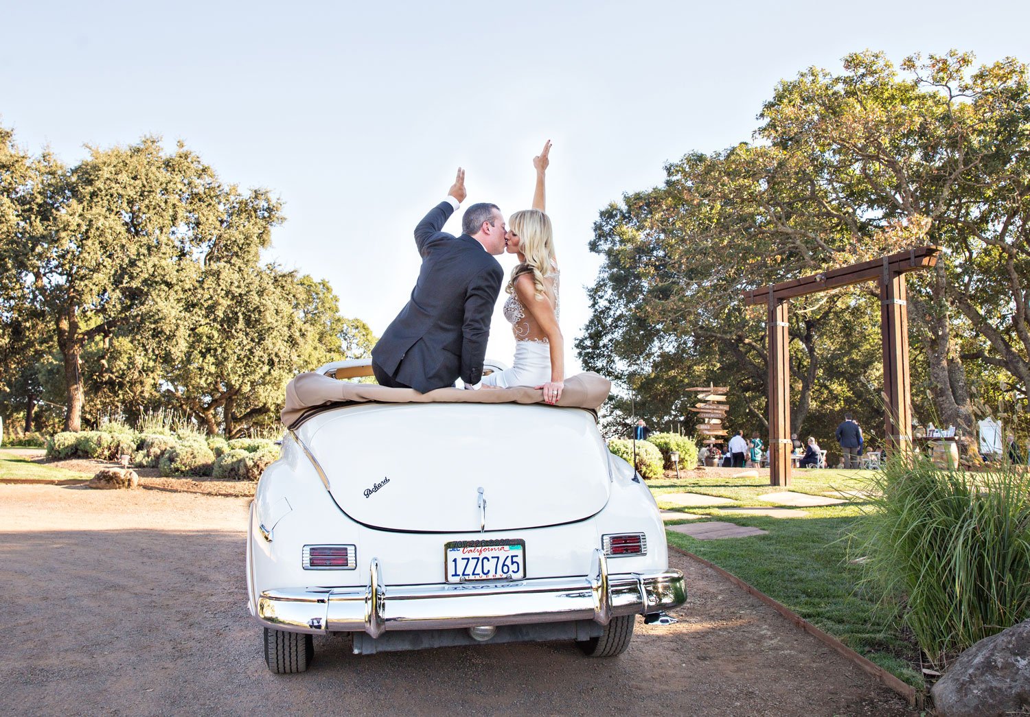 Bride & Groom Driving Off in Convertible