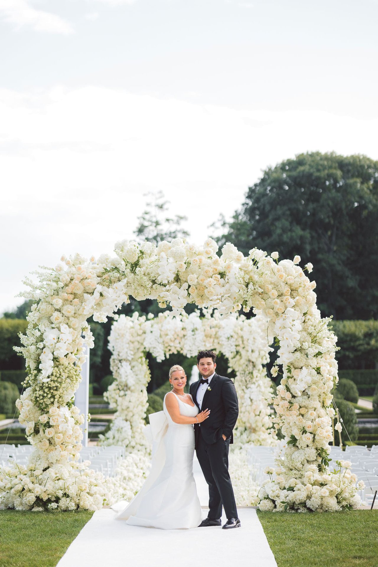Bride & Groom Under Floral Arch at Oheka Castle