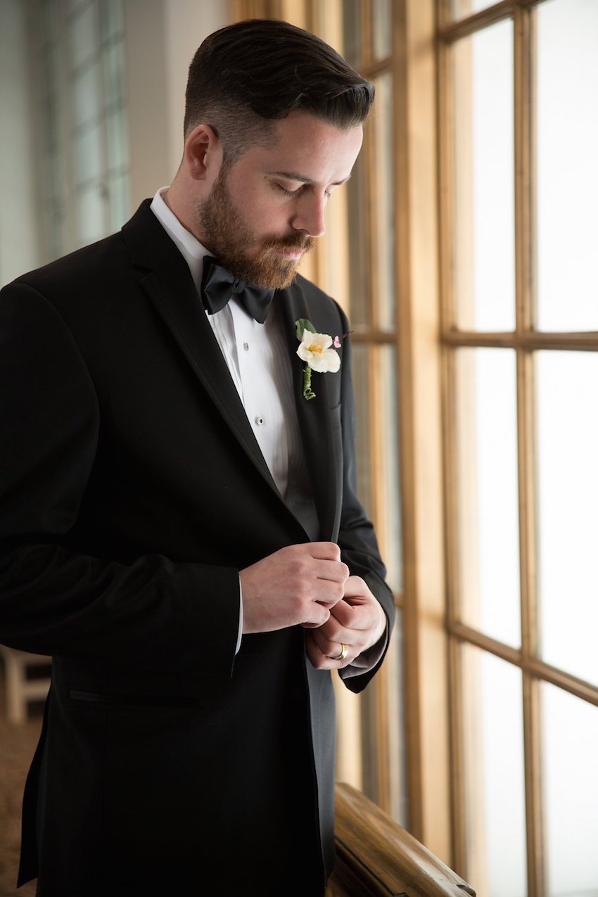 Groom Looking Out Window in Tux