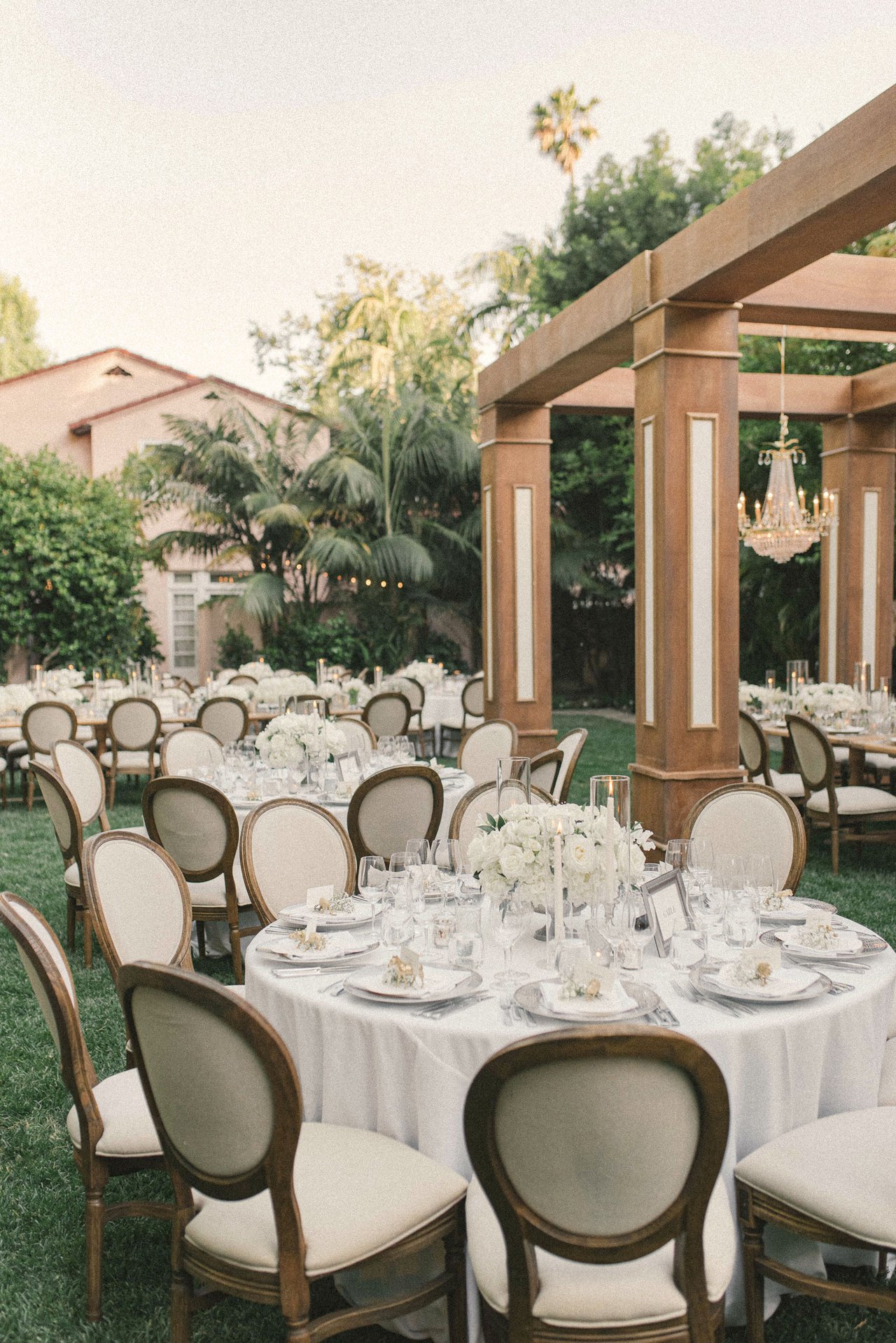 Round Tables with Wooden Chairs at Outdoor Reception